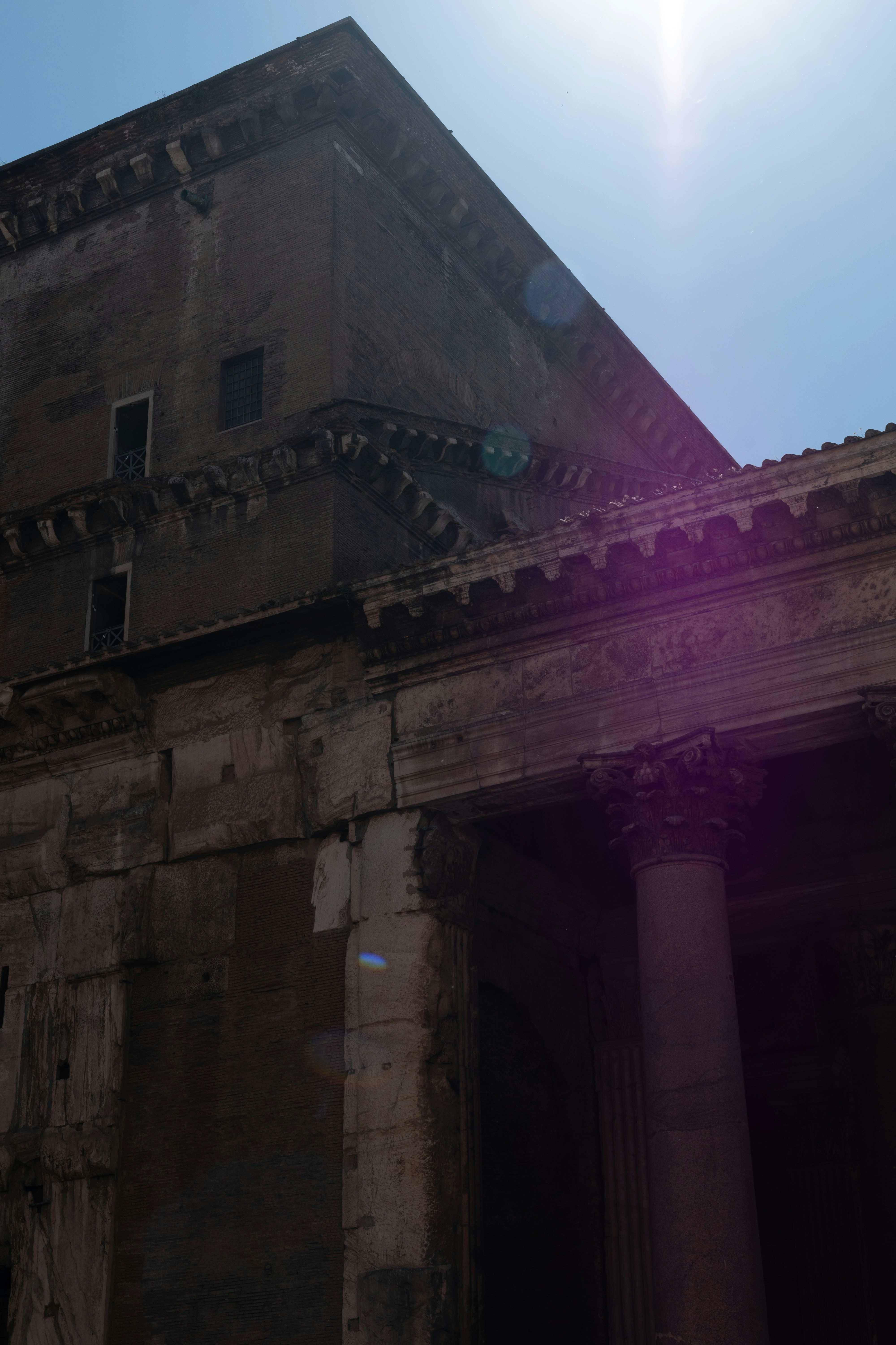 Sunlit Ruins: Classical Facade Rising into a Clear Sky