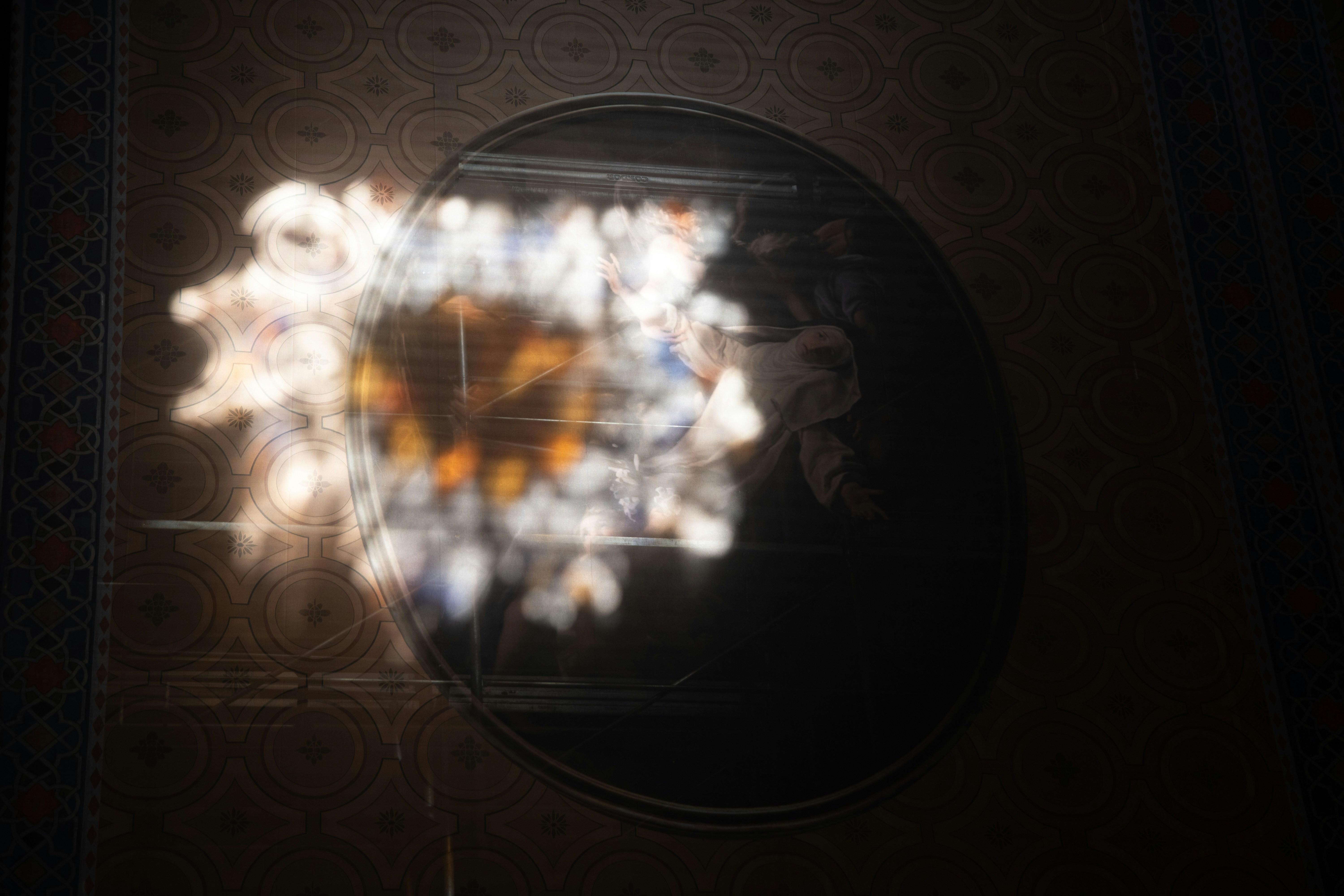 Circular Mirror with Blurred Flower Overlay in Dim Tile-Floor Setting