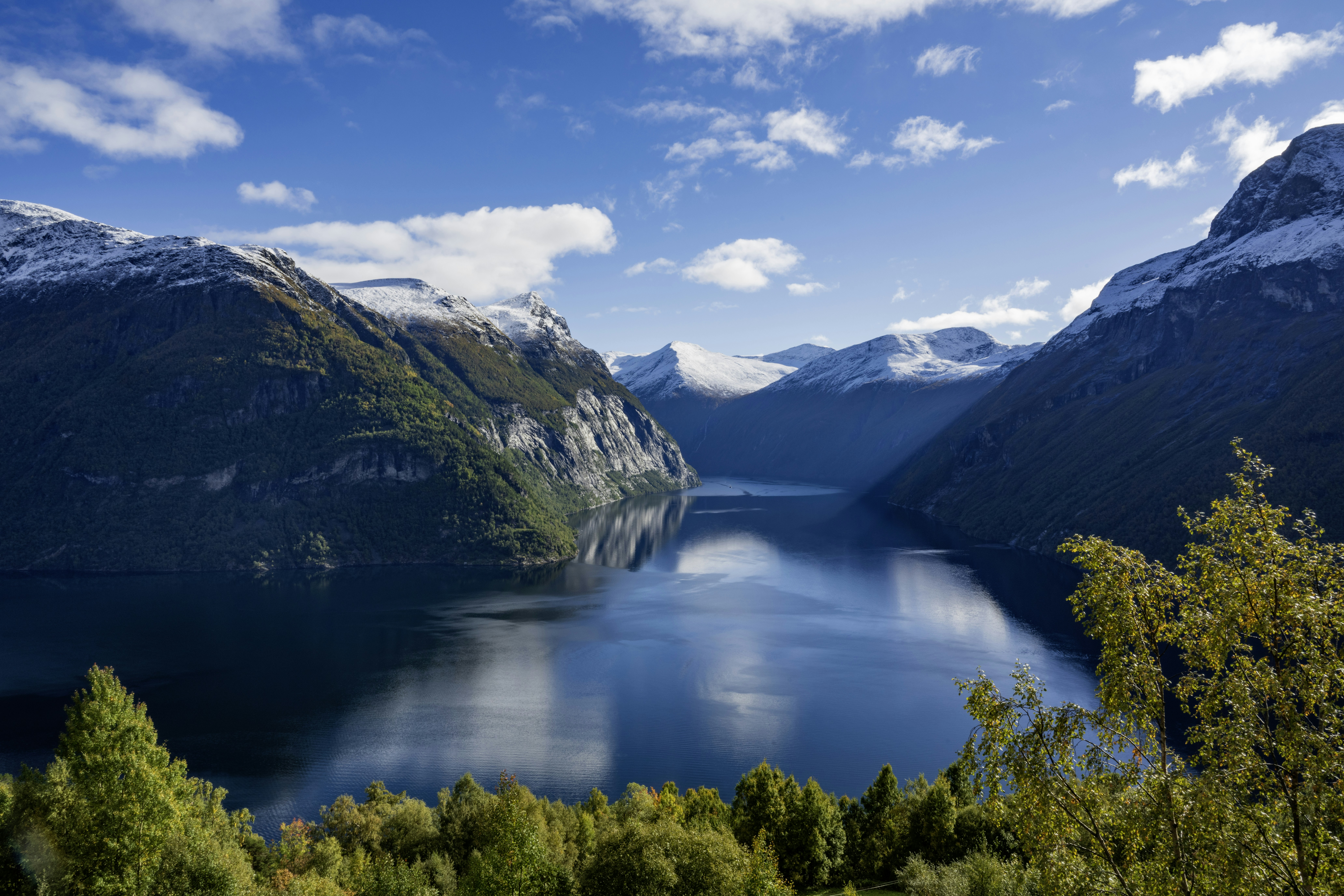 Azure Fjord Mirror: Snow-Capped Peaks Loiter Over Quiet Waters