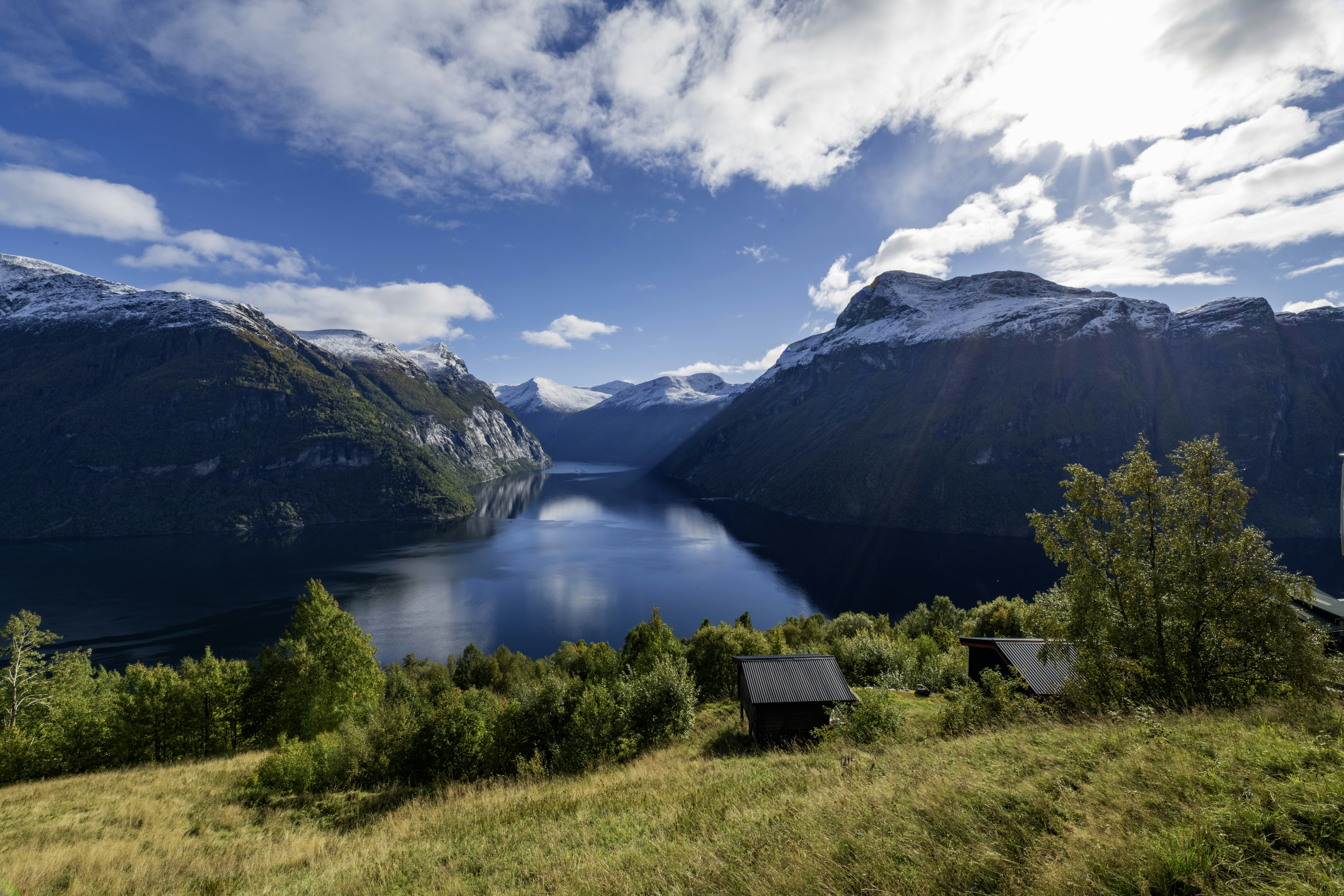 Sunlit Fjord Vista: A Quiet Valley Overlooking a Serene Waterway