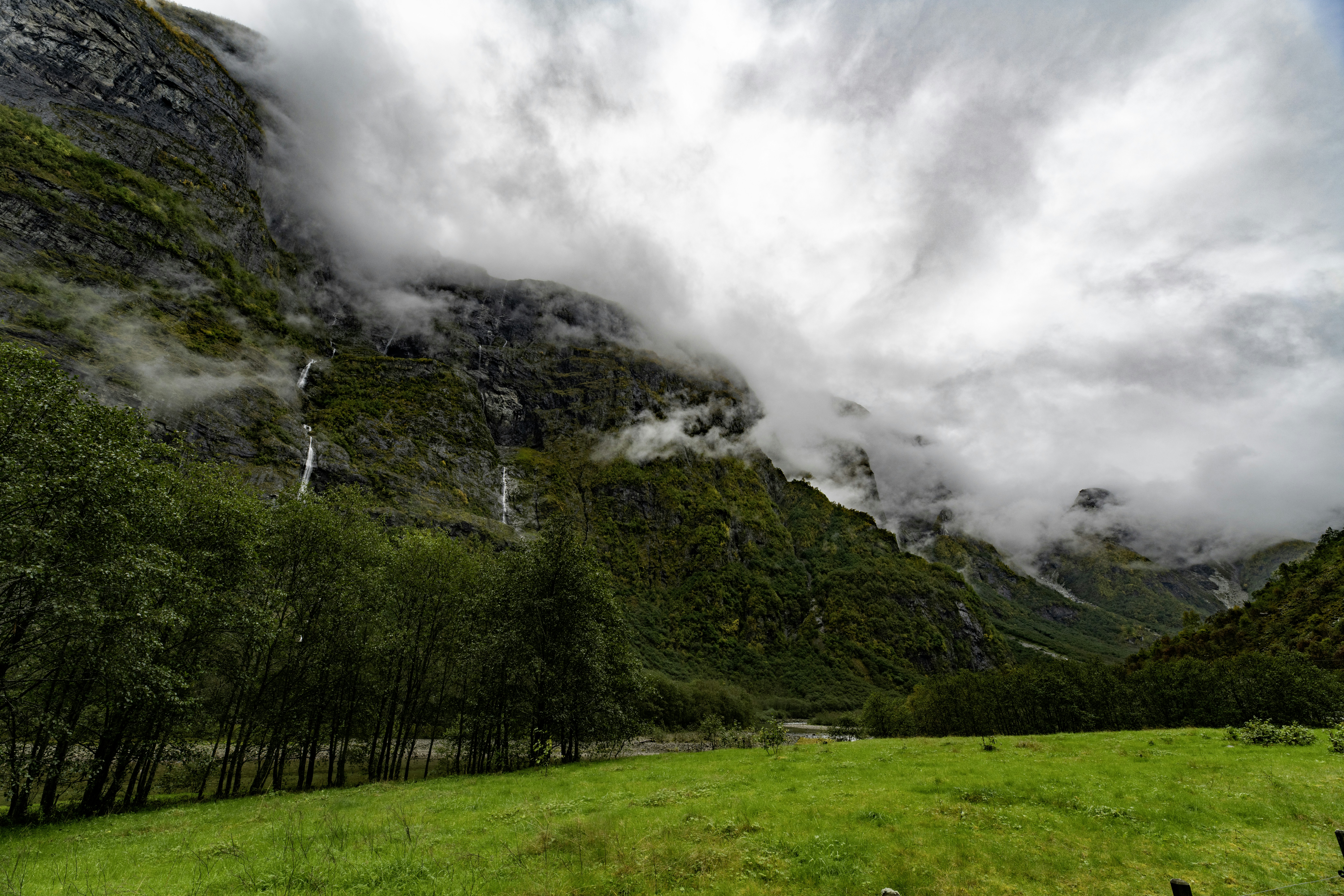 Mist over Ruined Peaks: A Green Vale to the Clouded Summit