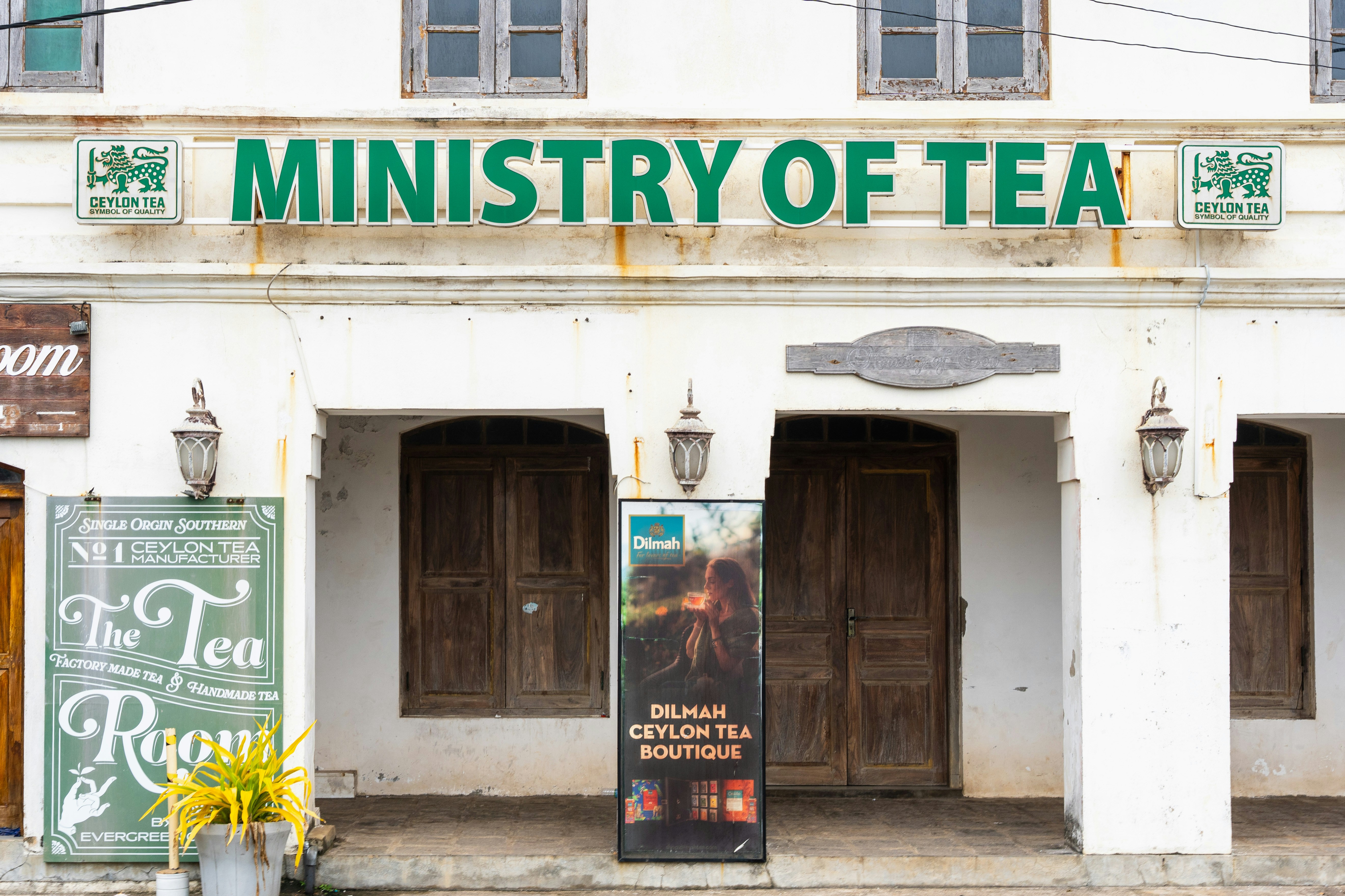 The Green Sign Above A White Facade: Ministry of Tea Boutique Front