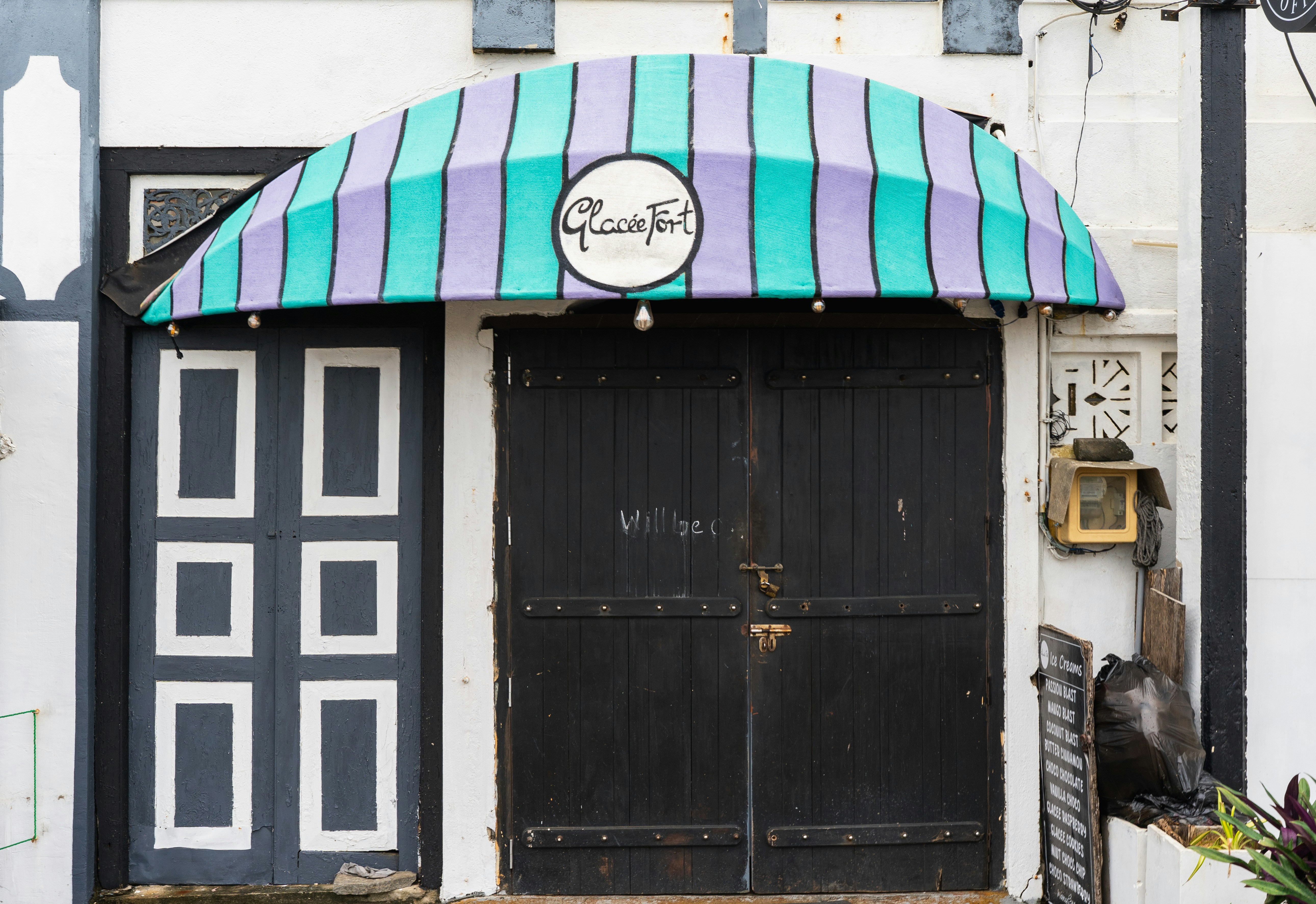  striped canopy over a weathered storefront