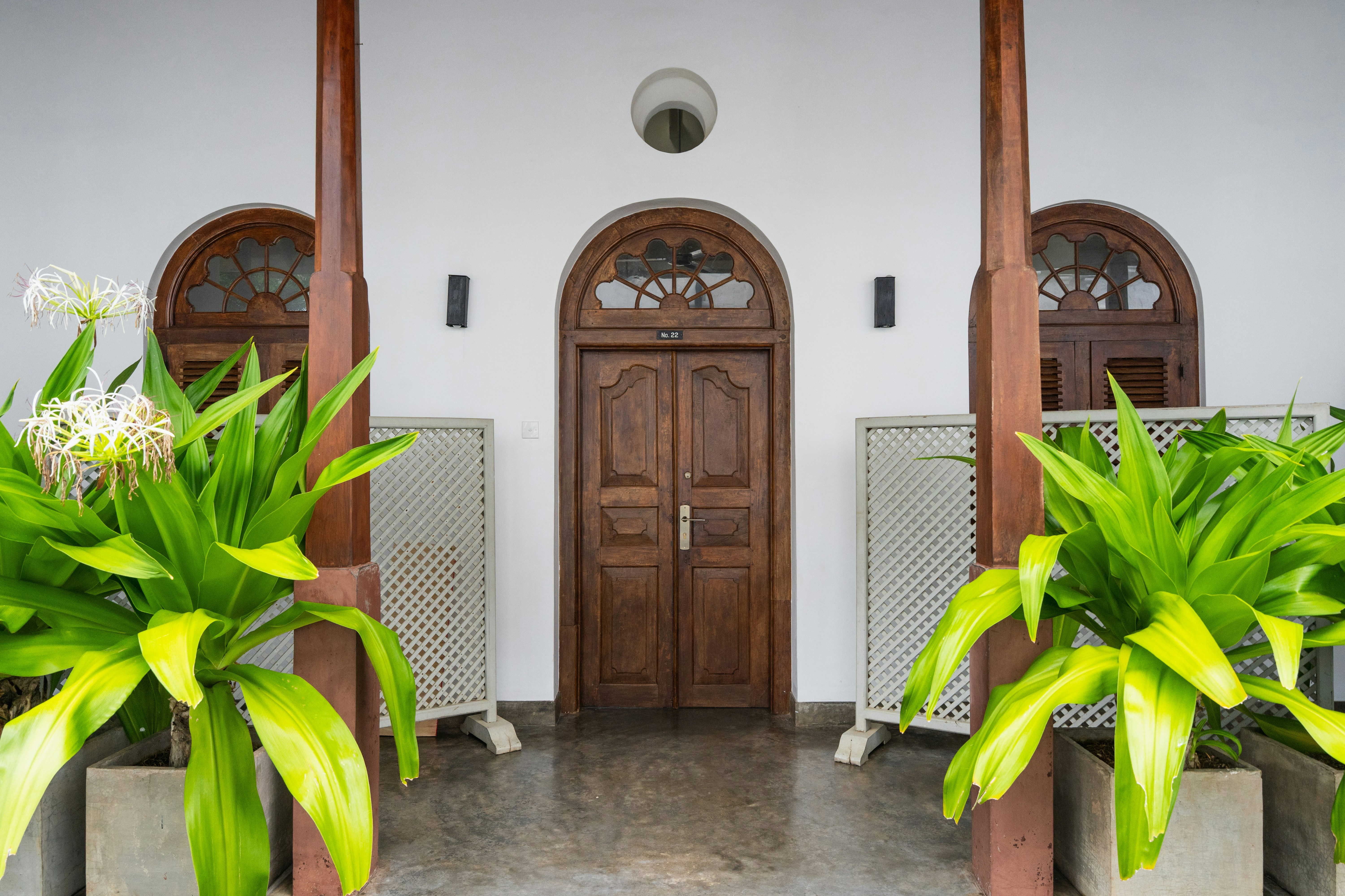 Traditional doorway framed by lush tropical leaves