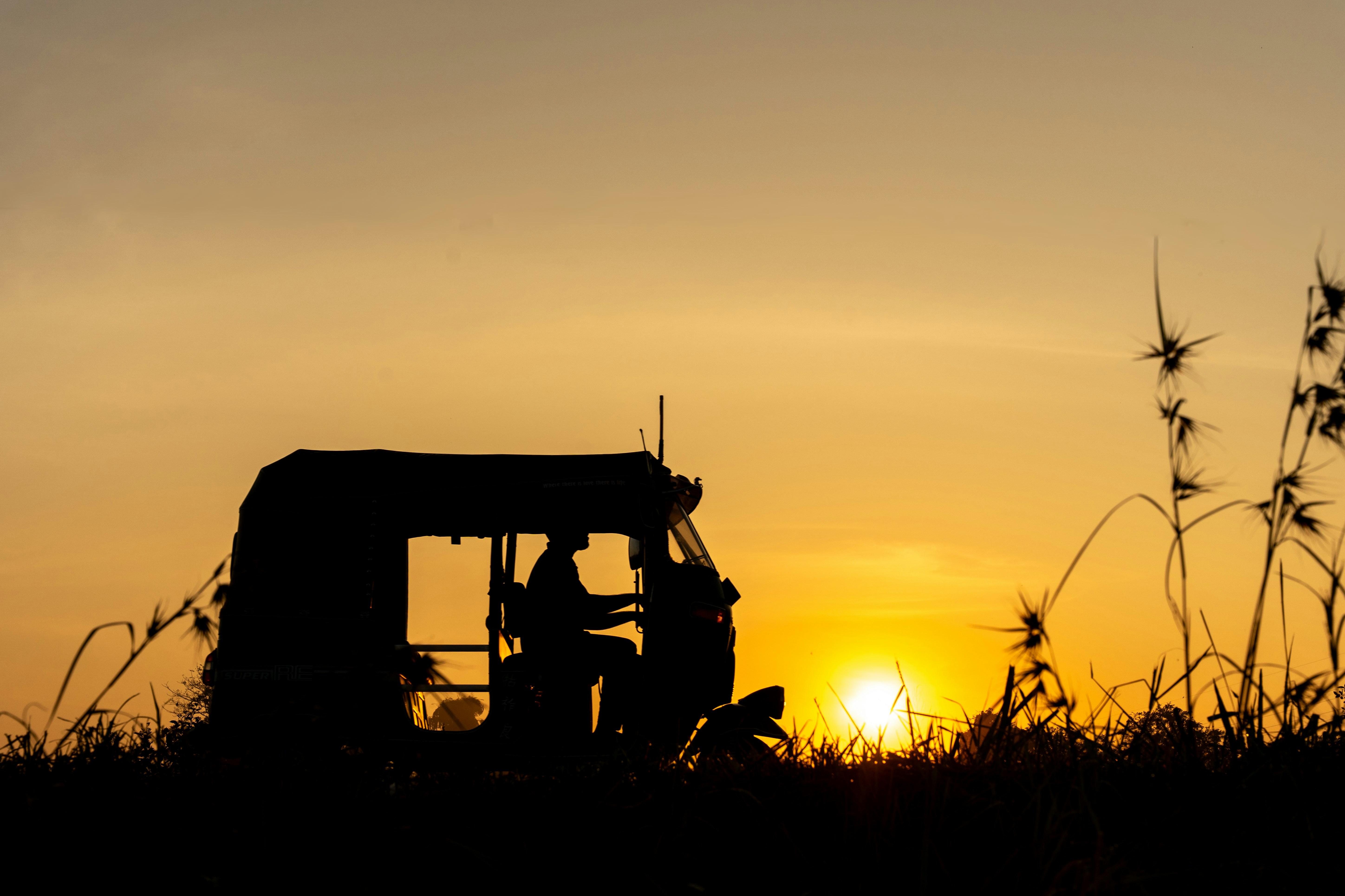 Silhouette at Dusk: An Off-Road Vehicle Anchors the Golden Horizon