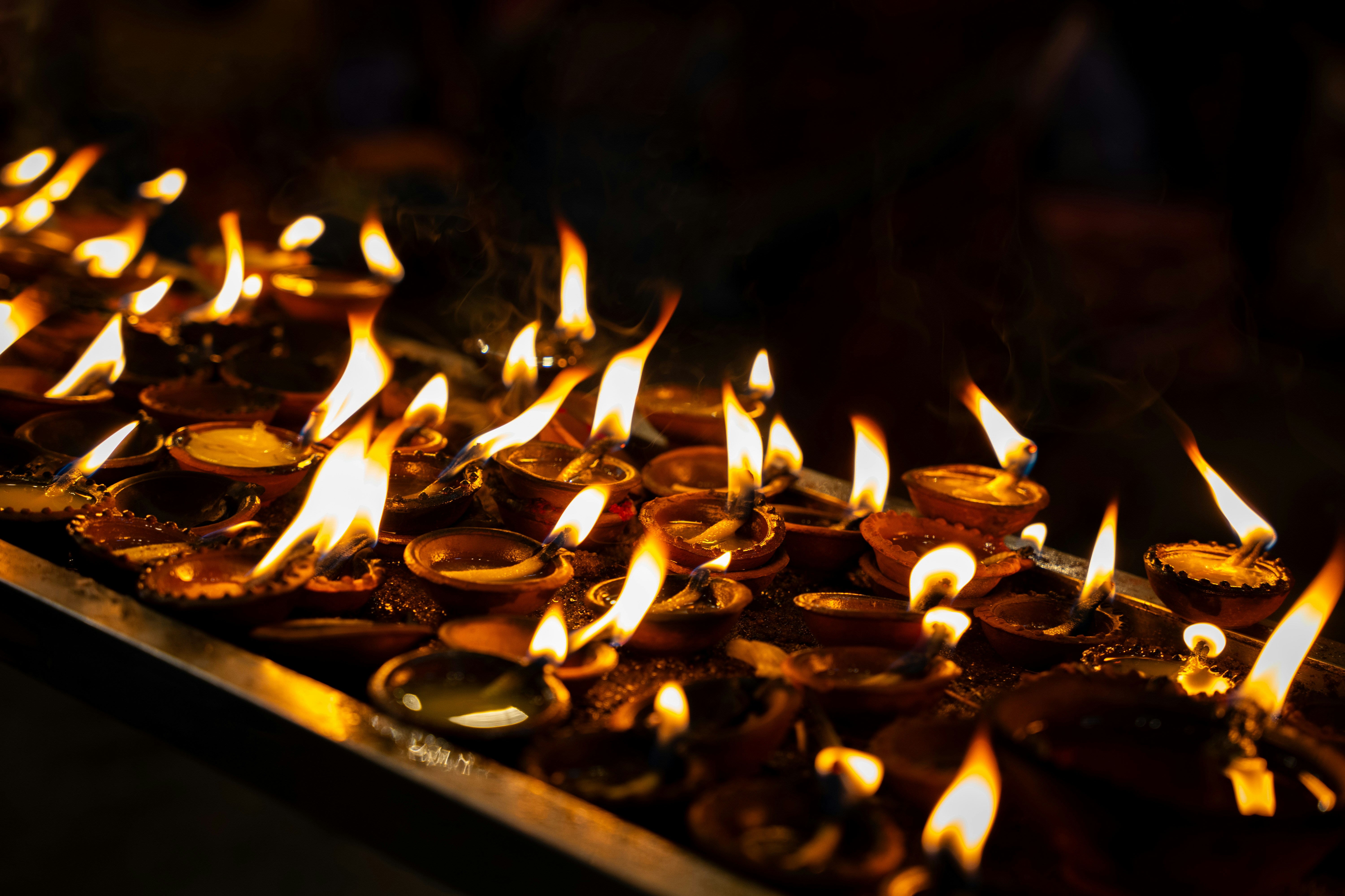 Flame Mosaic: A Row of Candles Illuminates a Quiet Shrine