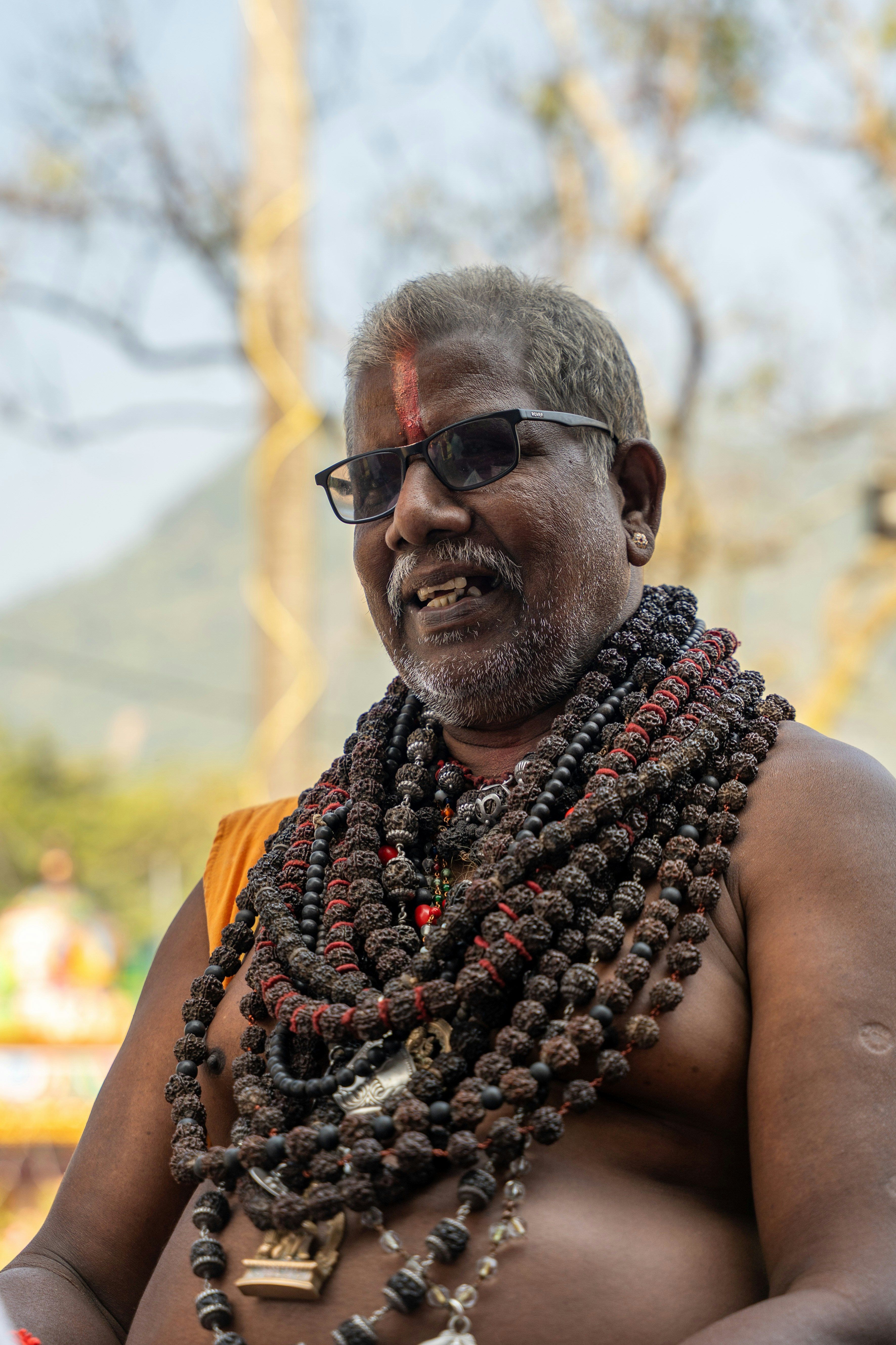 Beads of Tradition: A Colorful Elder in Meditation