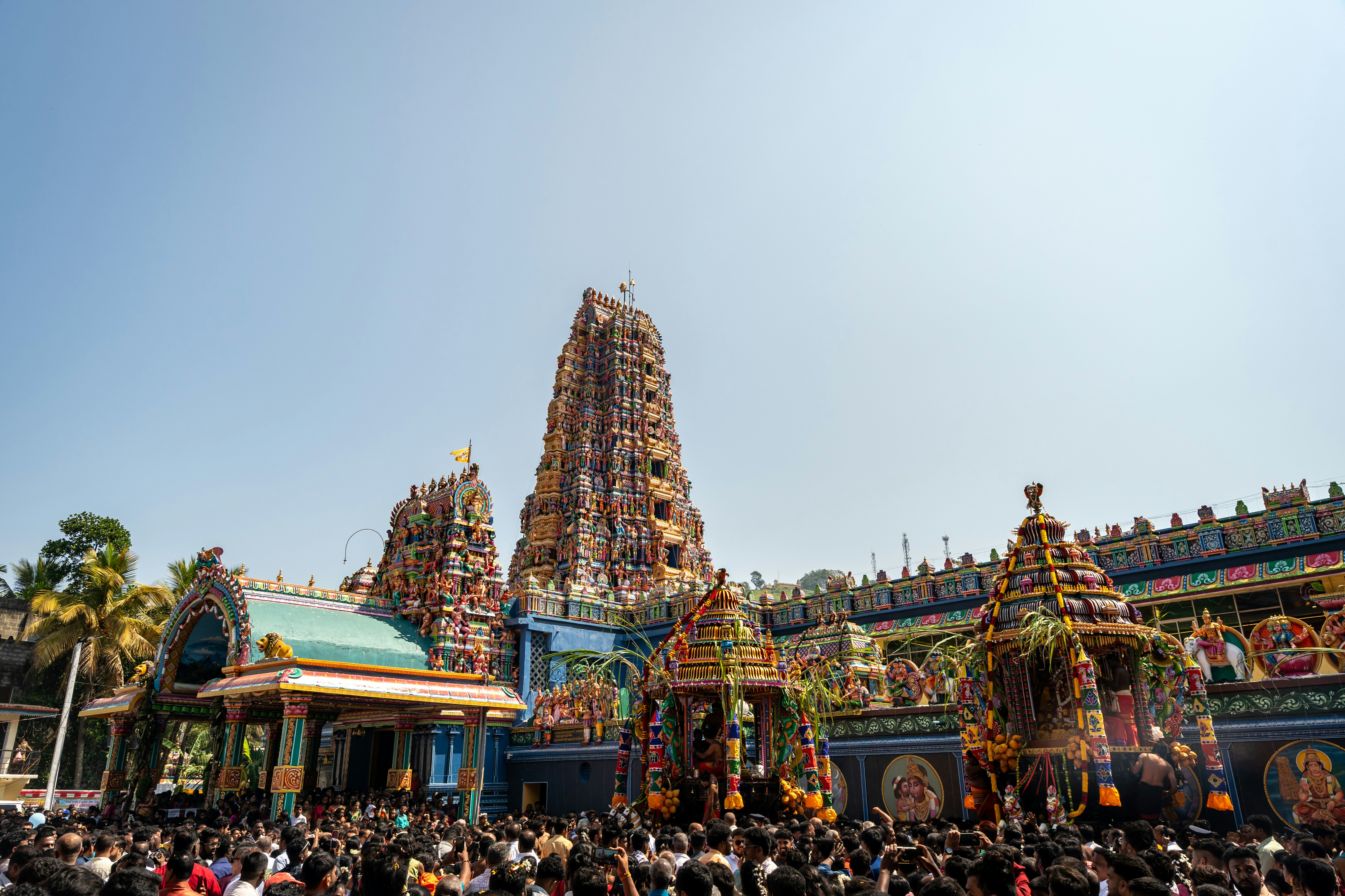 Gilded Gopuram Overlooking a Sea of Devotees at the Temple Complex