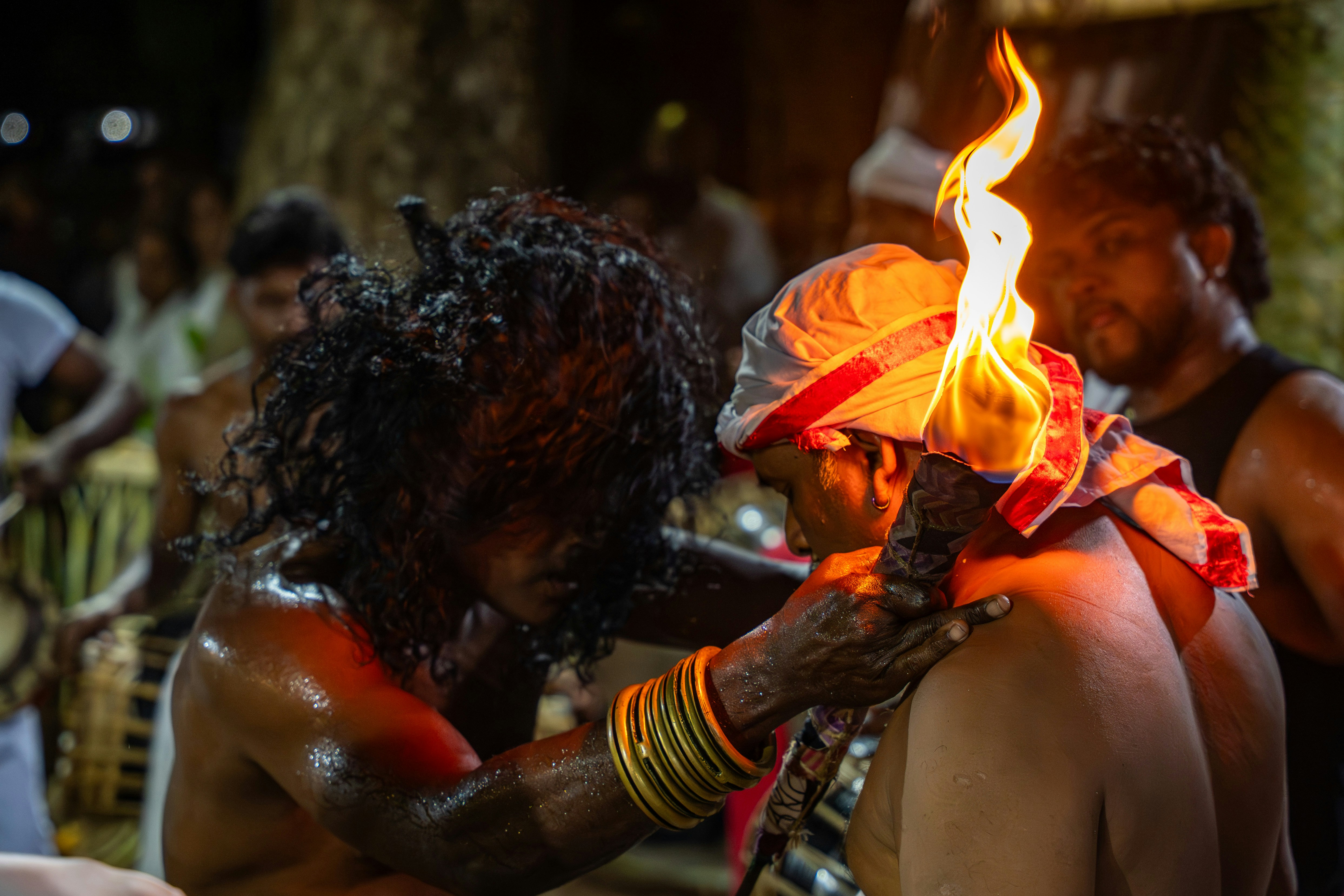 Flame Rite: Hands and Headdress Meet in Shared Firelight