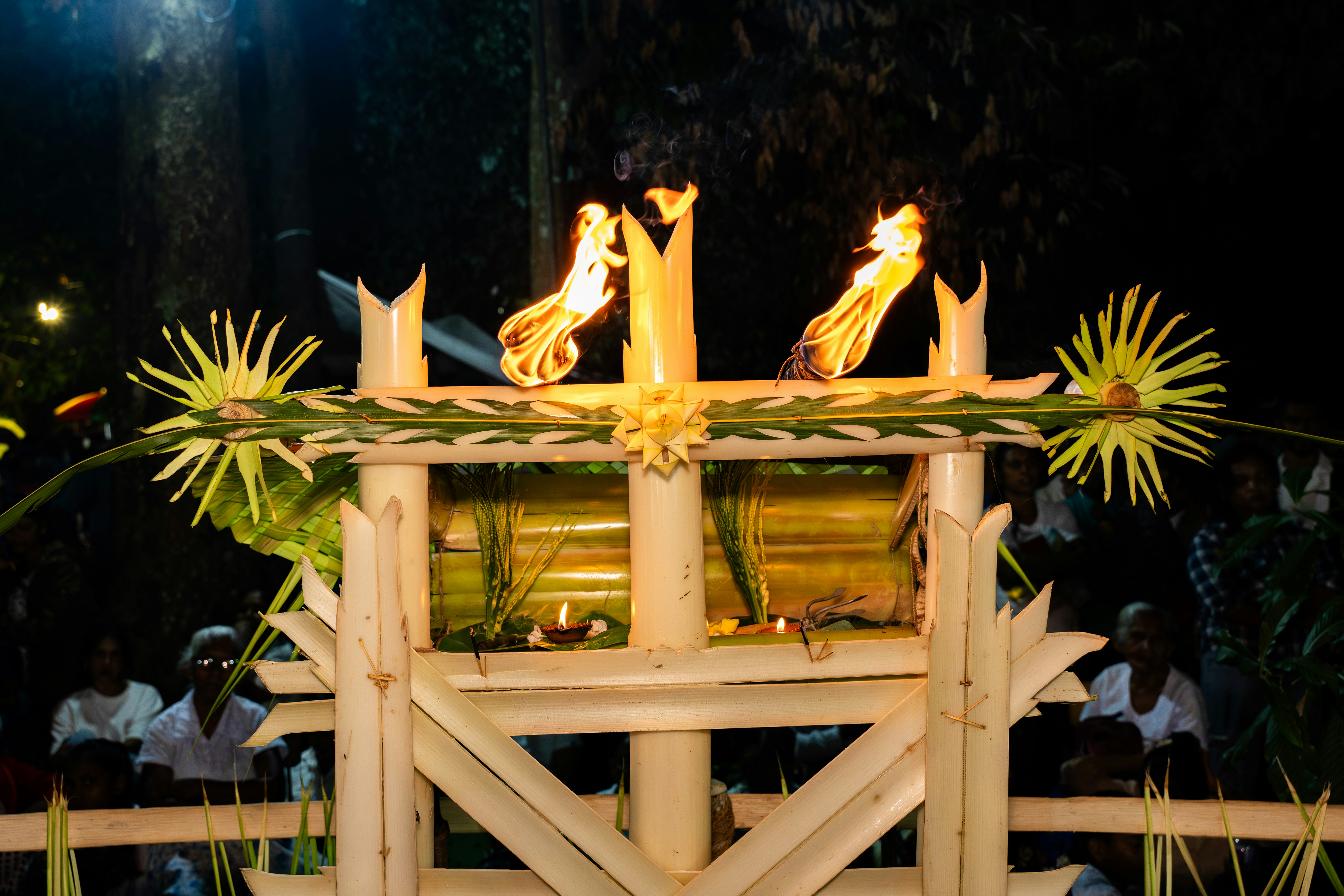 Candlelit Bamboo Shrine Rites Above a Festive Audience