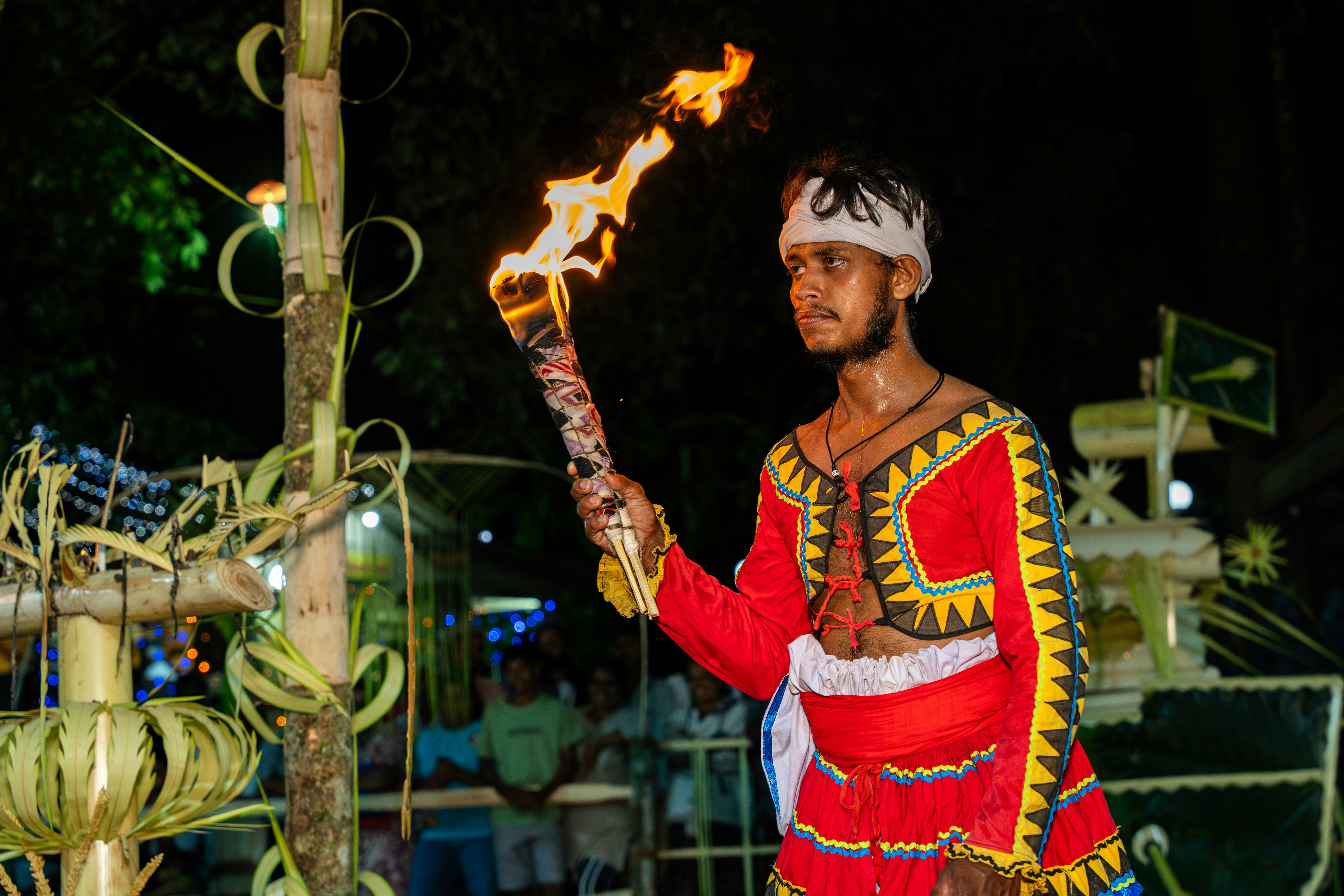 Keeper of Firelight: Street Performance with Torch in Colorful Ethnic Attire