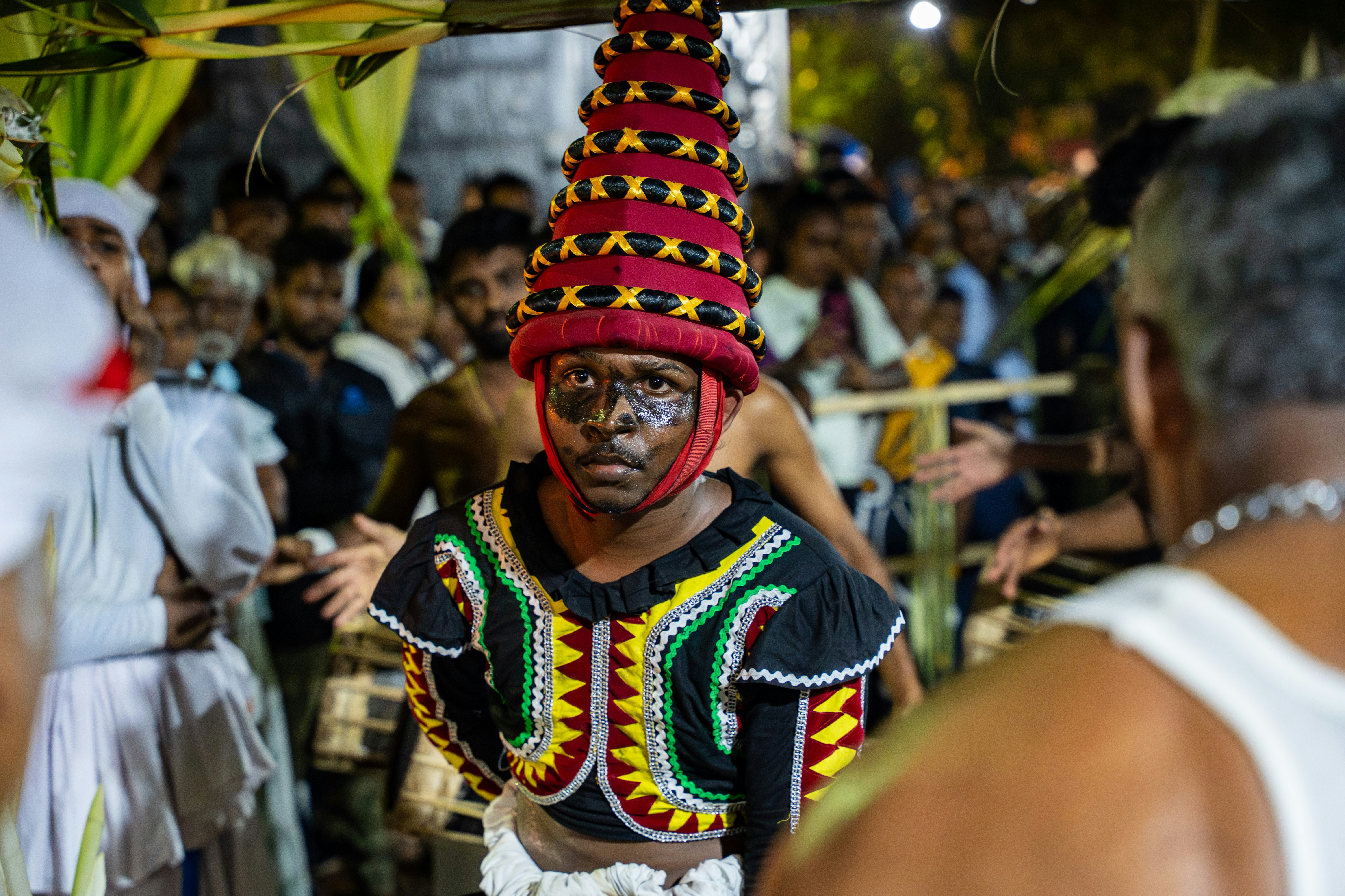 The Dancer in Colorful Ceremonial Attire Under the Festival Canopy