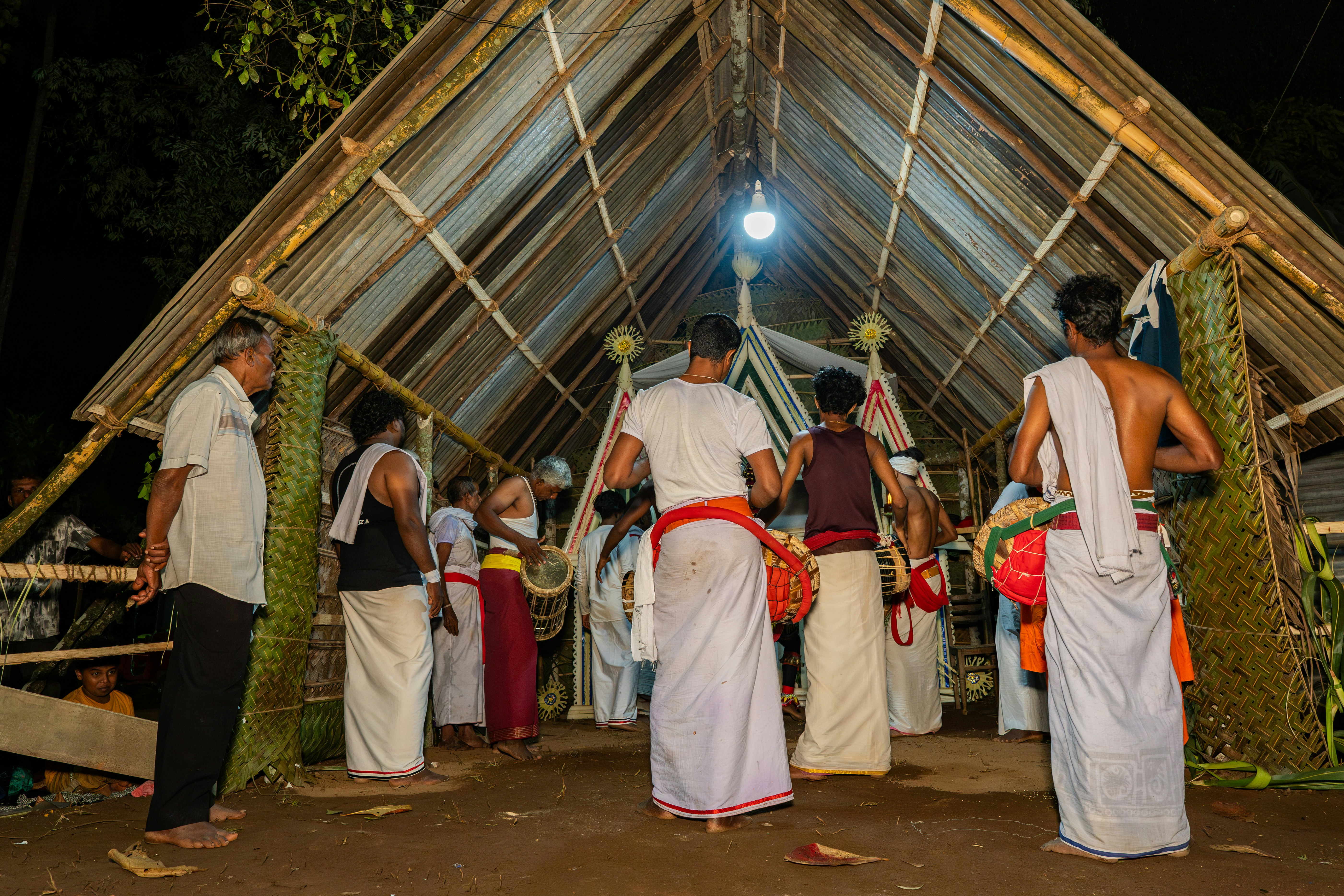 Night Ceremony Under a Bamboo Roof: Unity in White and Color