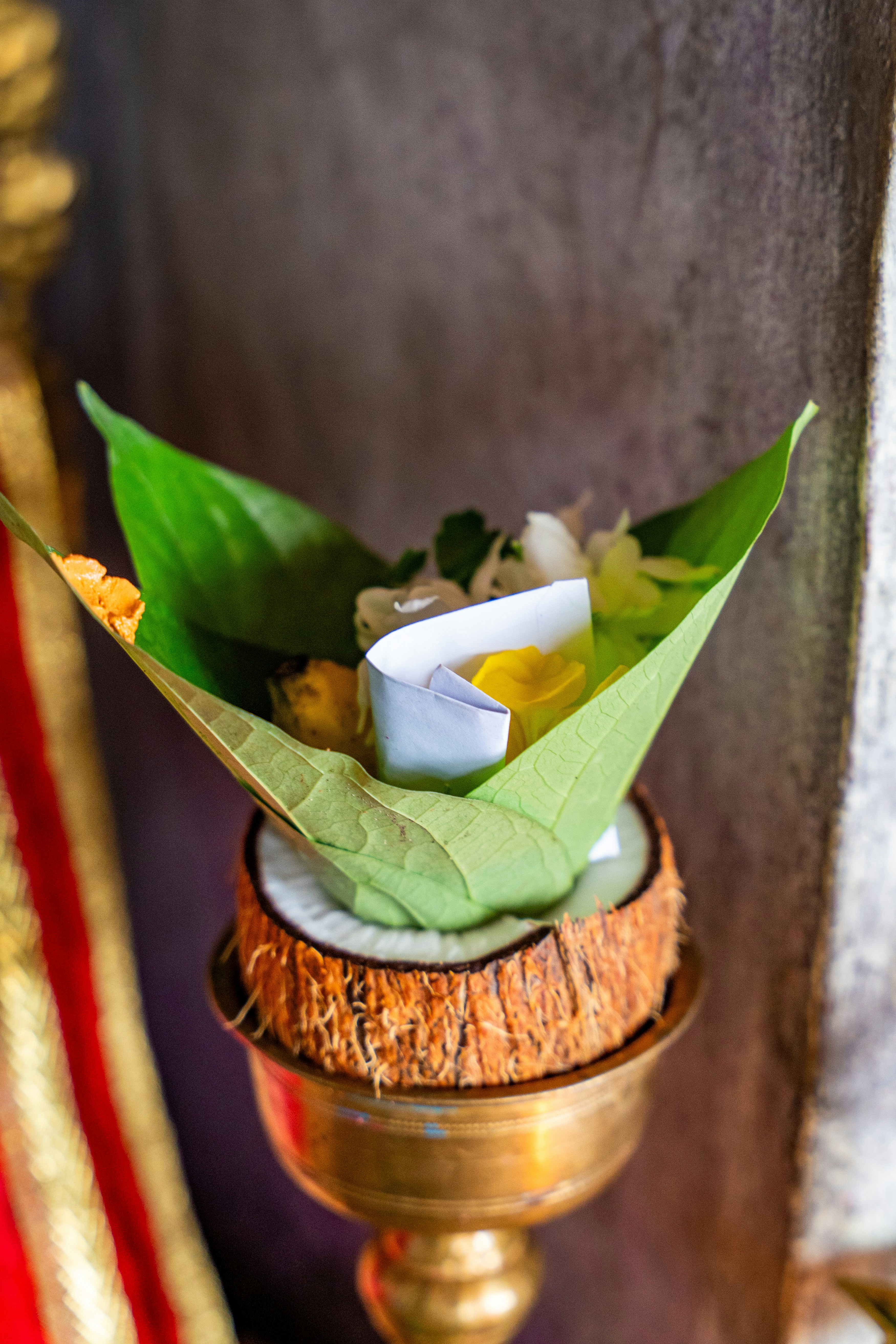 Leaf-Wrapped Floral Arrangement Nestled in a Coconut Husk Vessel