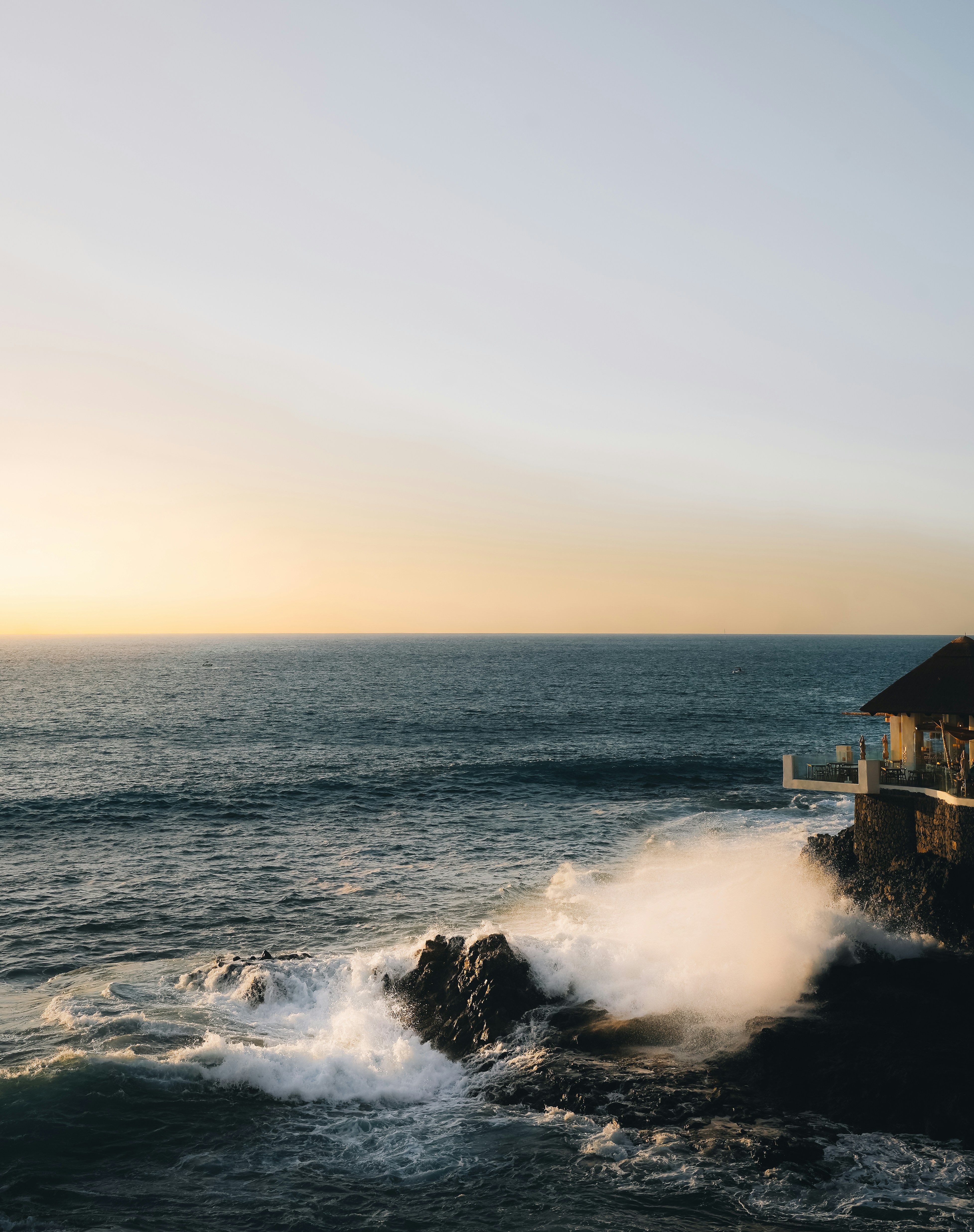 Cliffside at Dusk: Ocean's Edge and Soothing Raillight