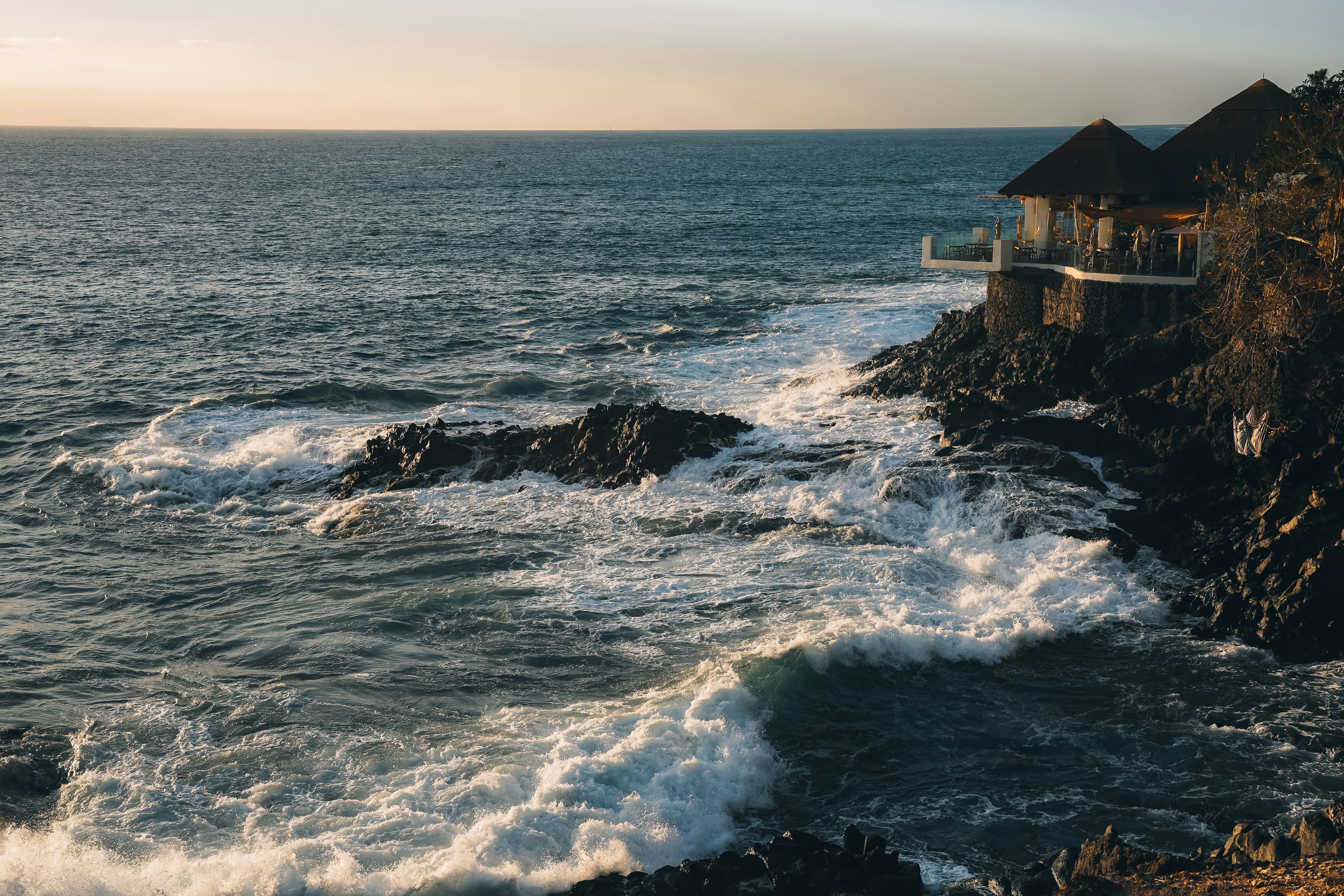 Clifftop Terrace Overlooking Turbulent Coast at Sunset