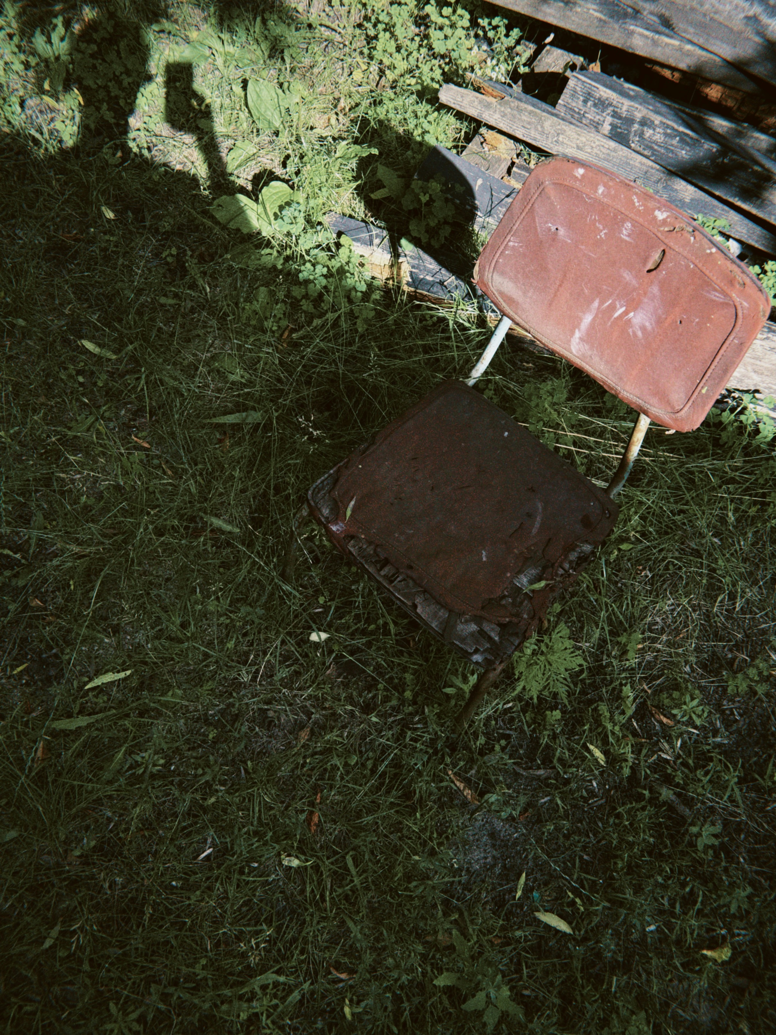 Weathered Chairs Under Dappled Shade