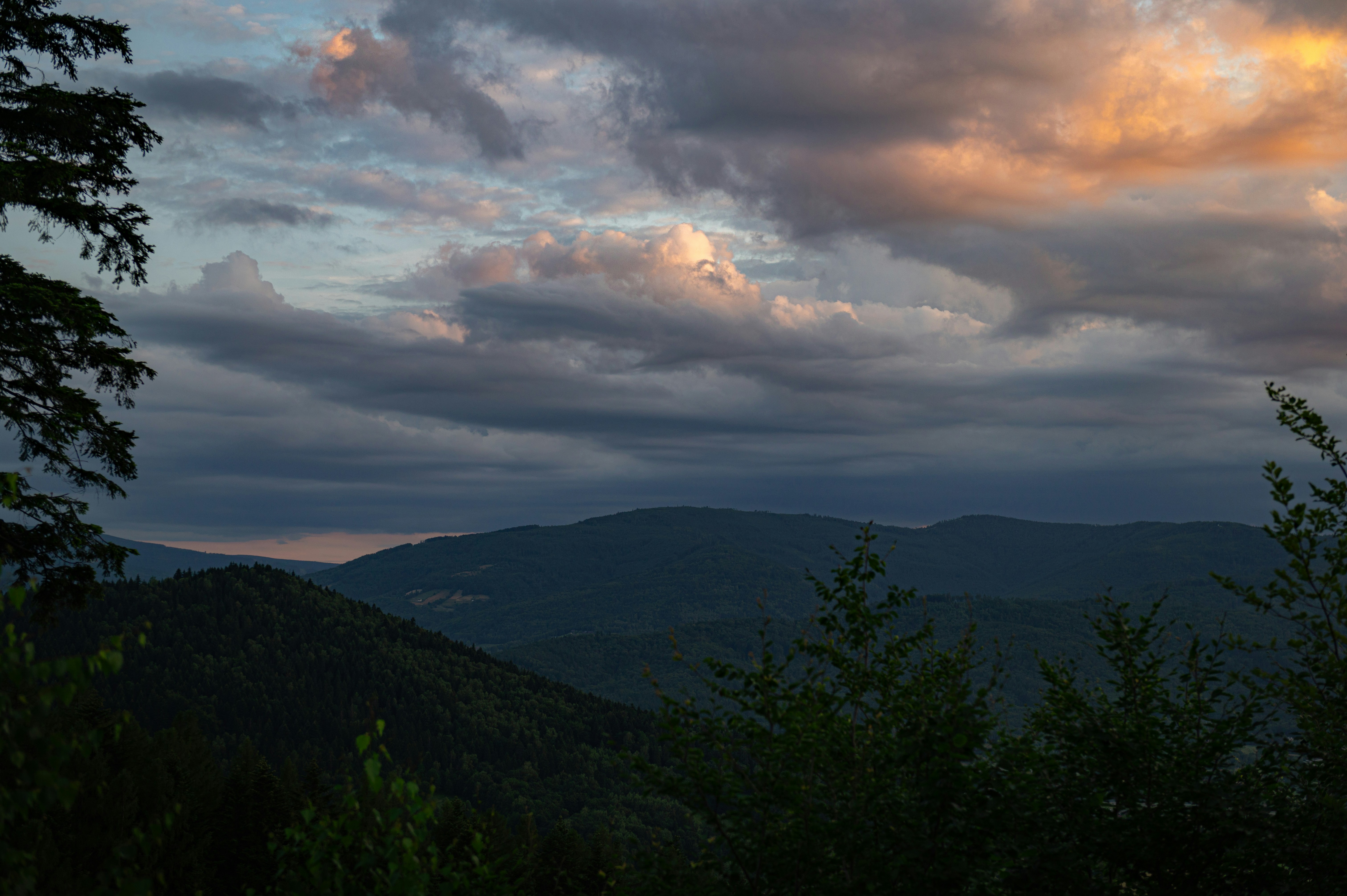 Dusk Over the Ridge: Clouds Casting Color Across a Quiet Valley