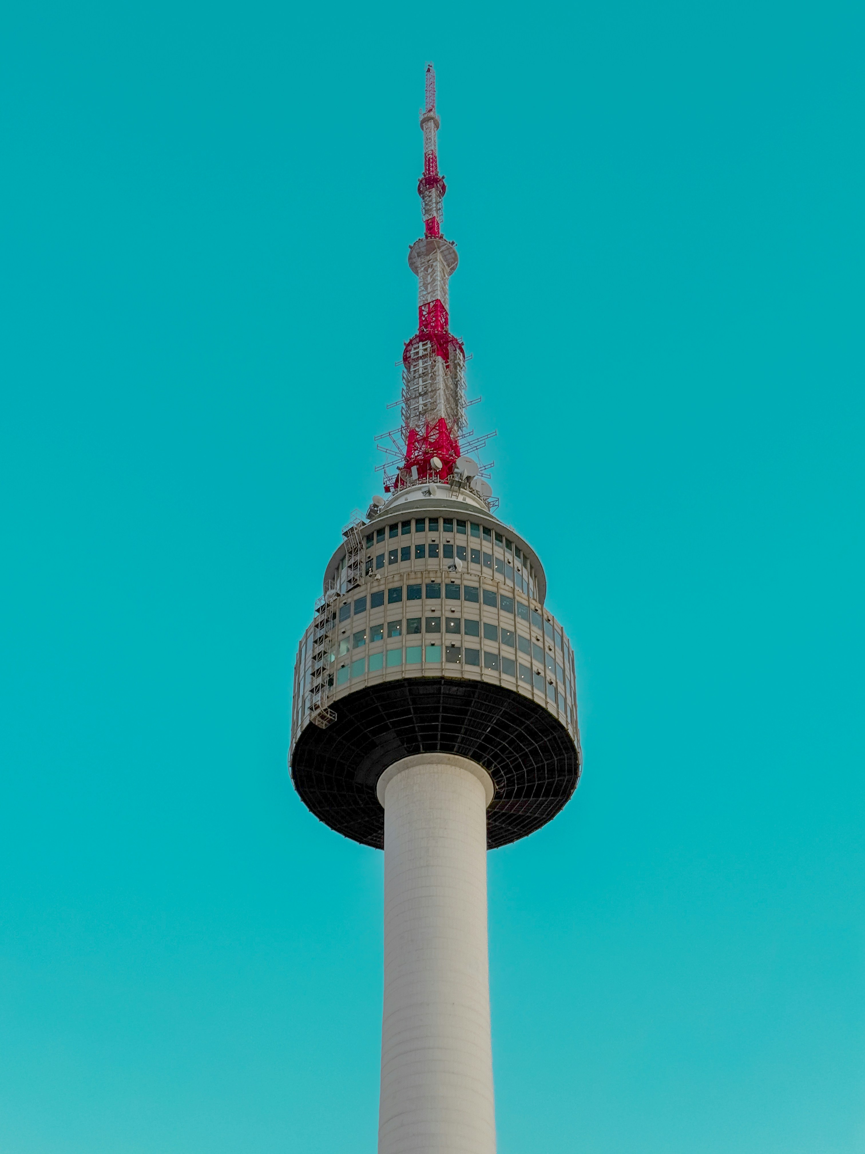 Skyward Signal: The Turreted Spire Reaches Into a Clear Teal Sky