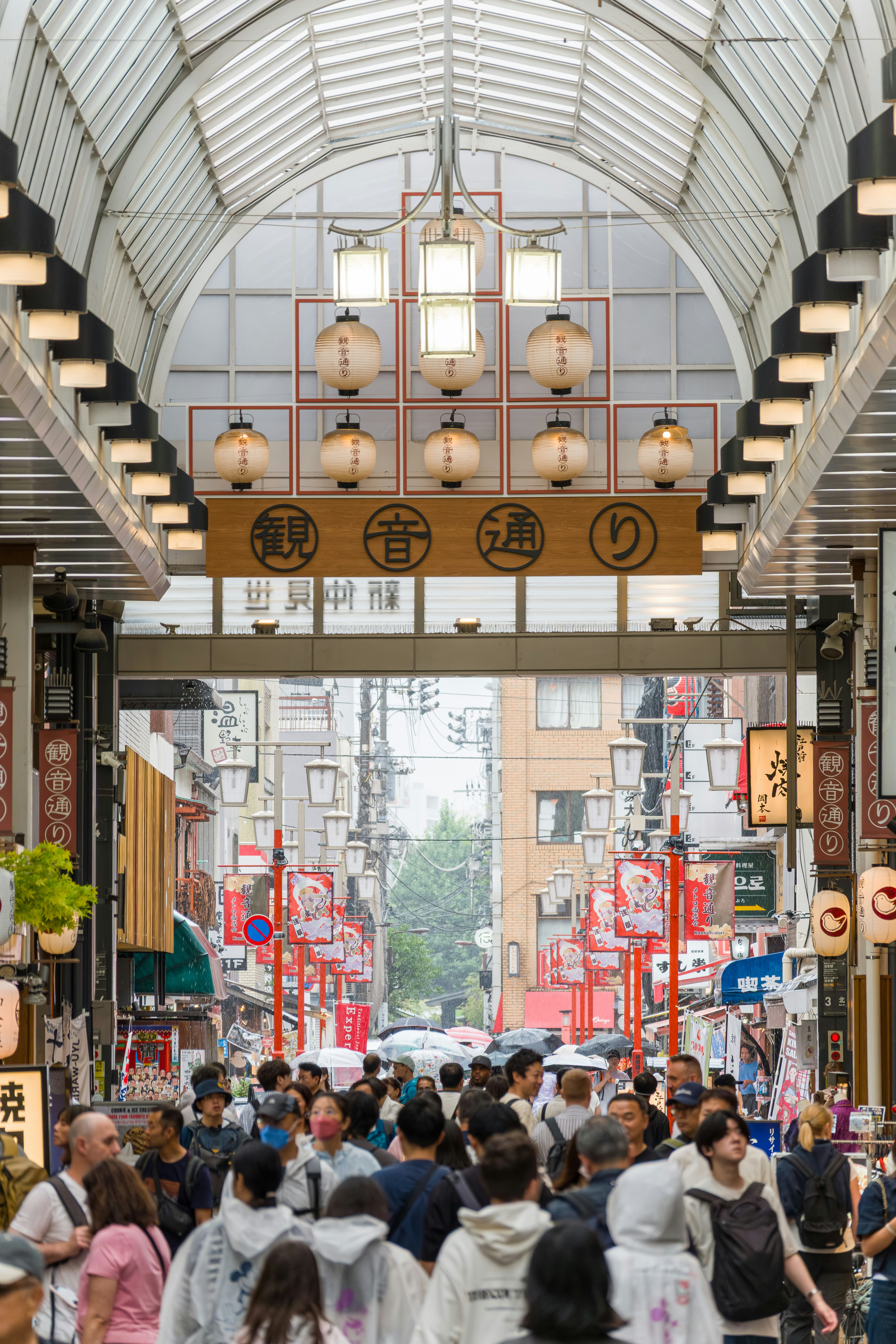 Lanterns and Lanes: A Busy Street Market Under an Arched Canopy