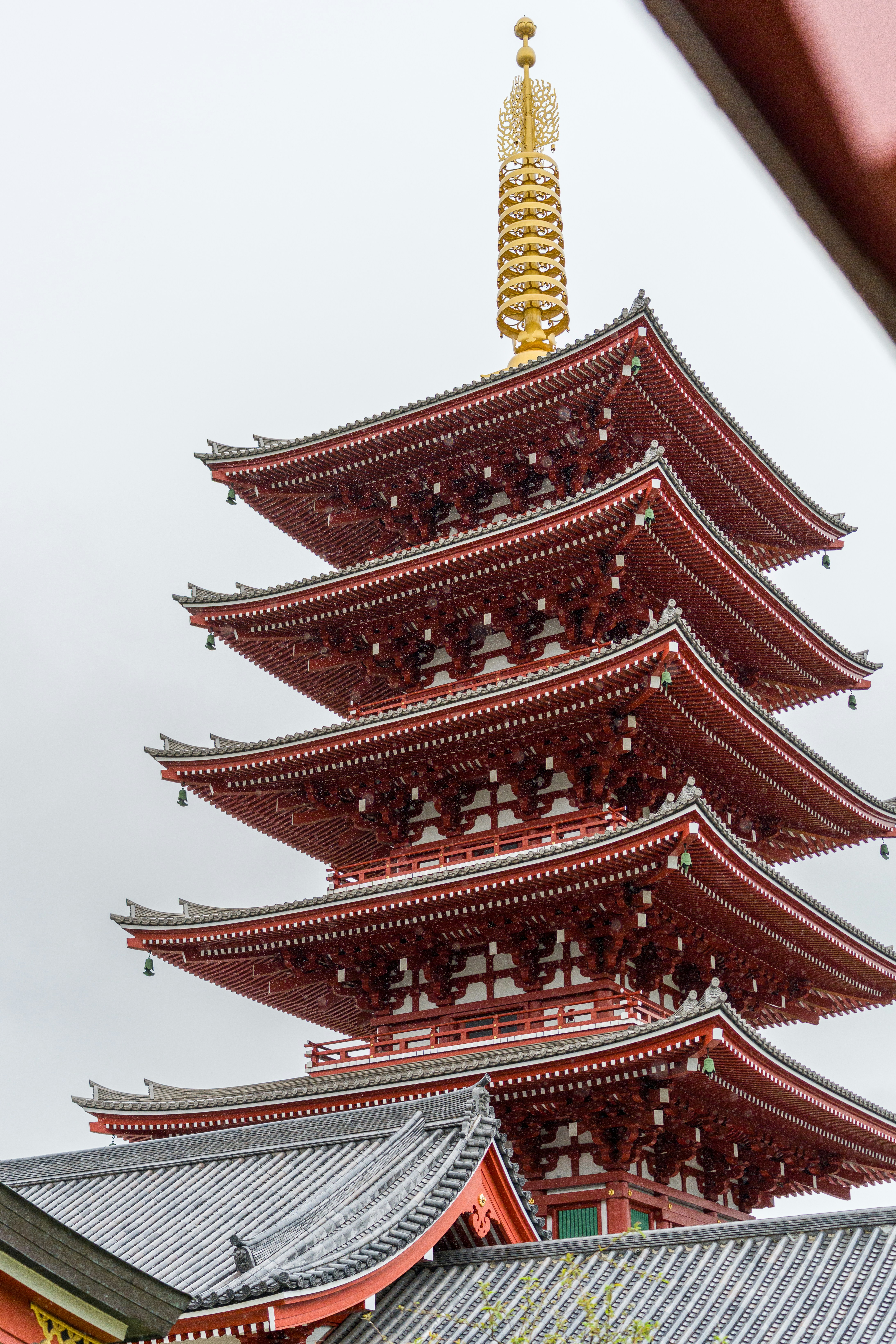 Apex of Tradition: The Five-Story Pagoda Reaches Toward a Cloudy Sky