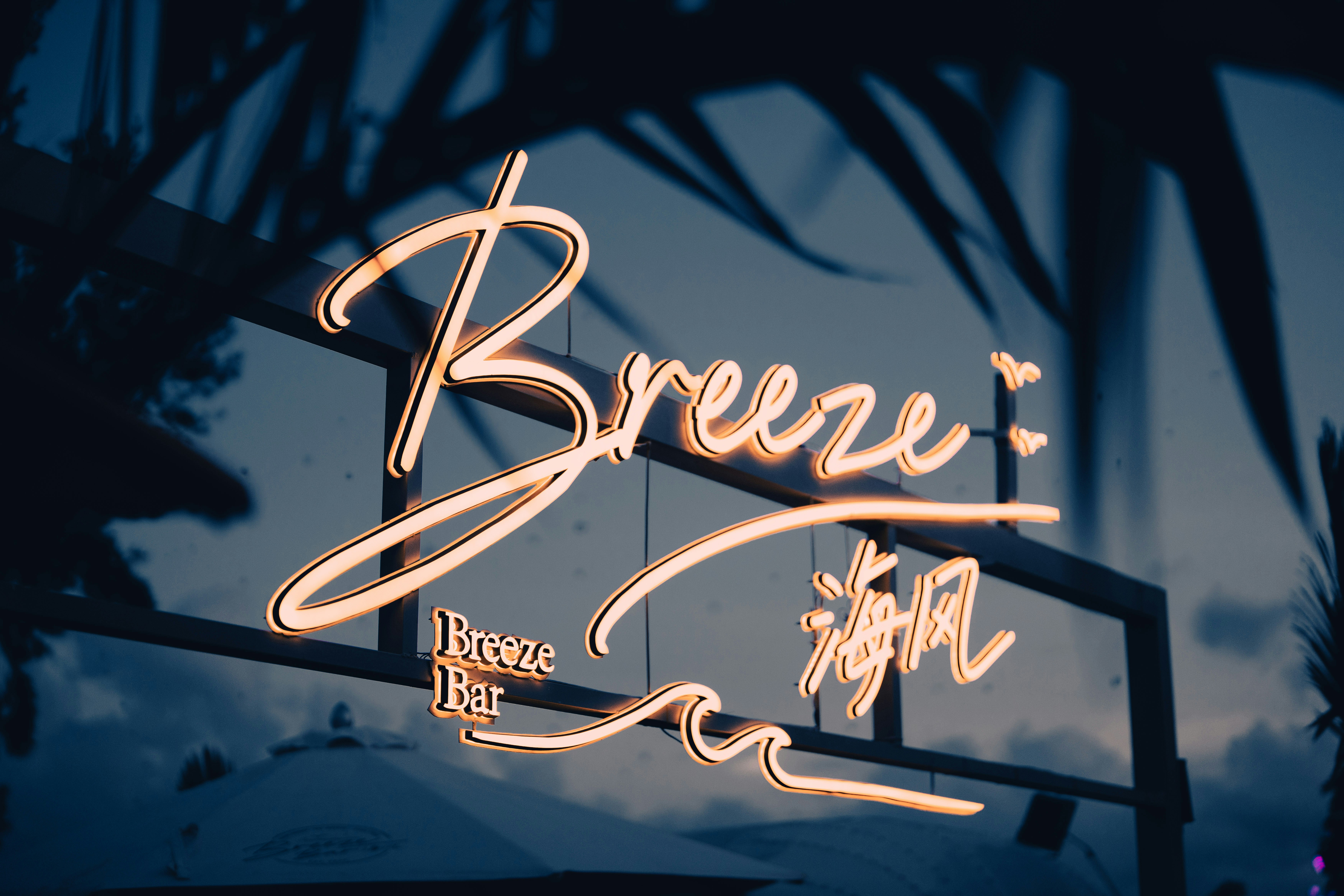 Neon Breeze Overwater: A Glowing Sign in Blue Hour