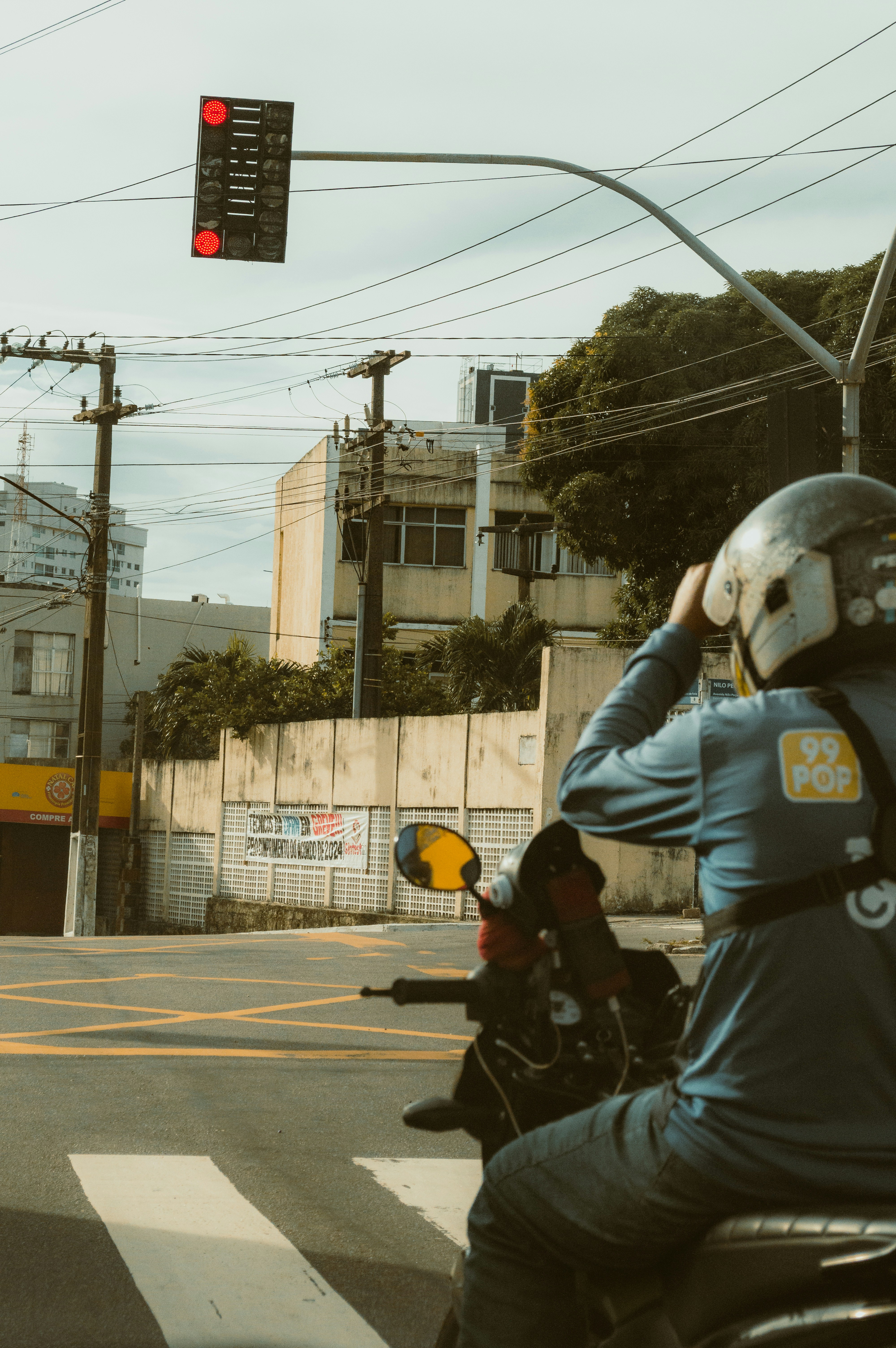 Crosswalk Signal: A Rider Turns toward the Streetlight Horizon