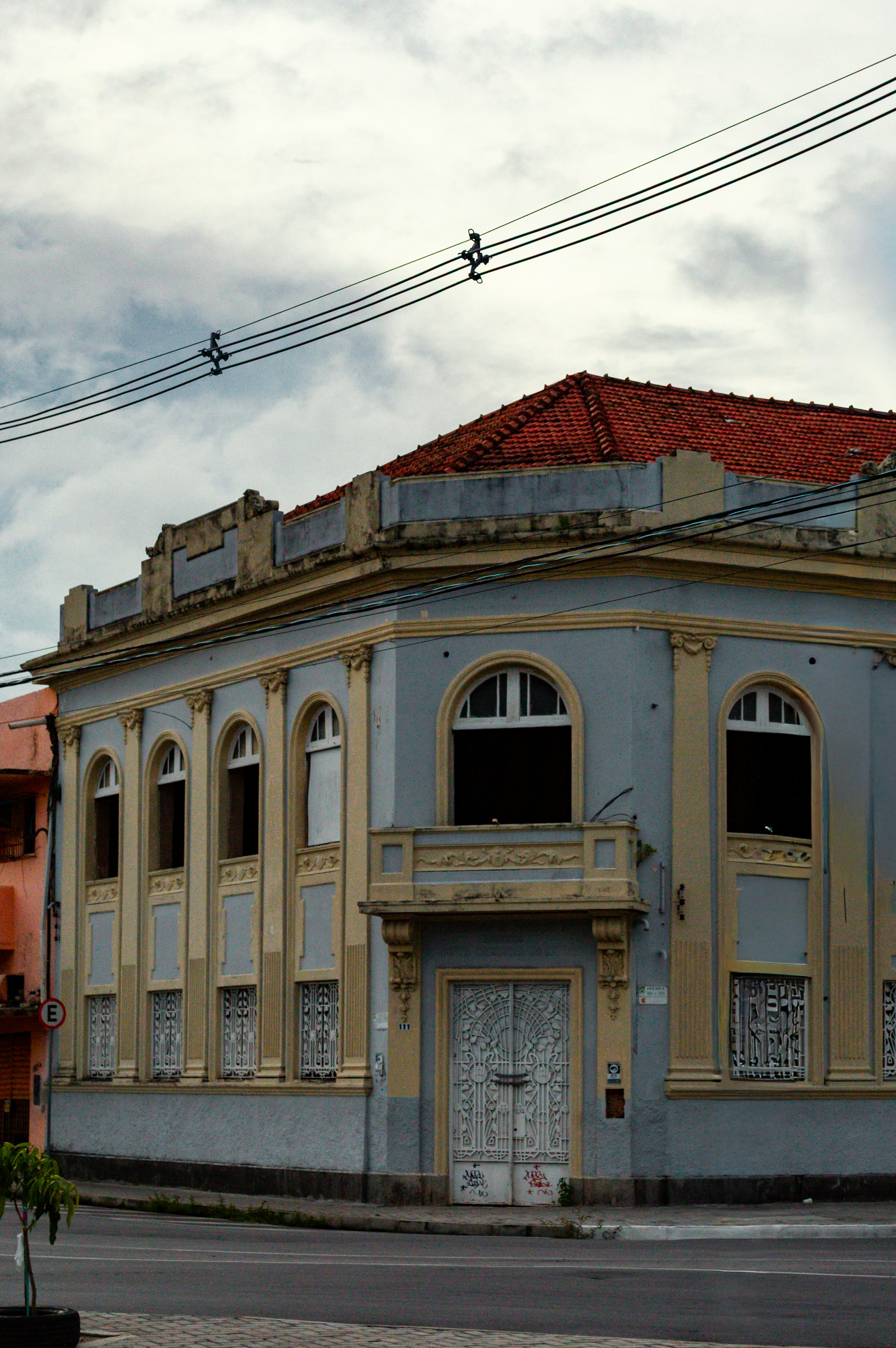 Pastel Corner: A Classical Building Under Quiet Power Lines