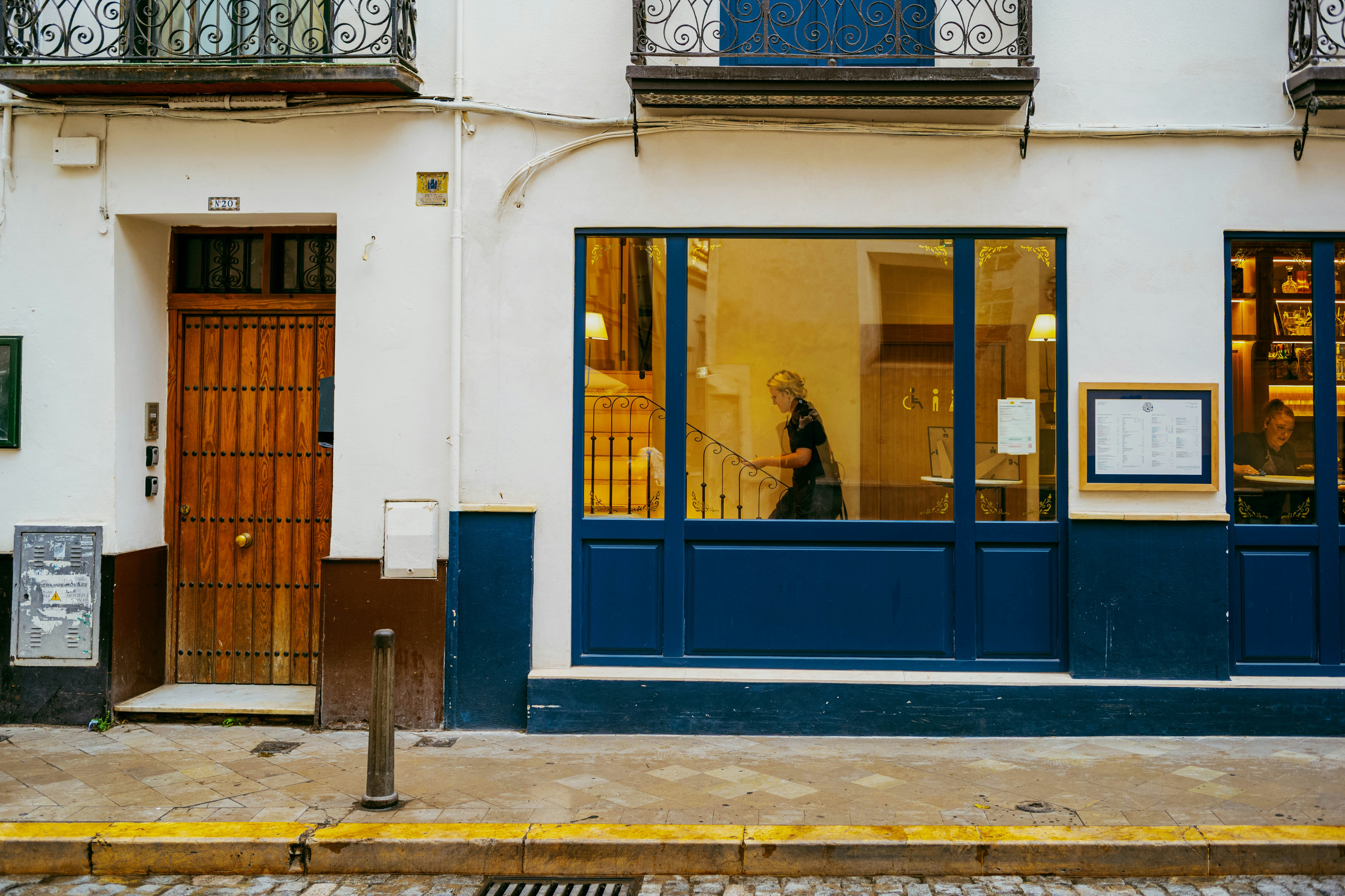 Blue doorways and warm interior glow: a quiet street scene
