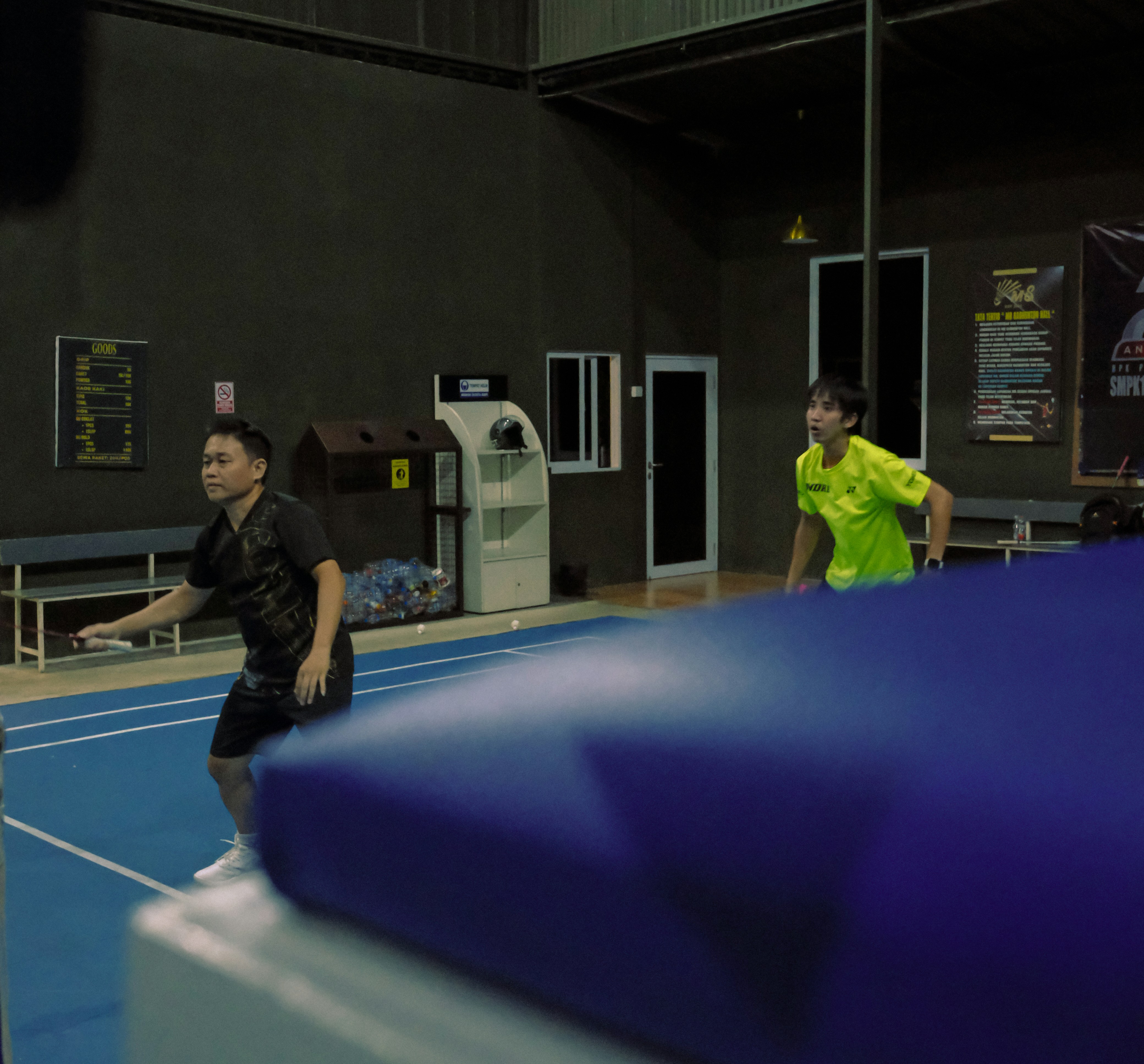 Two Players in an Indoor Table Tennis Drill, Focused on Movement