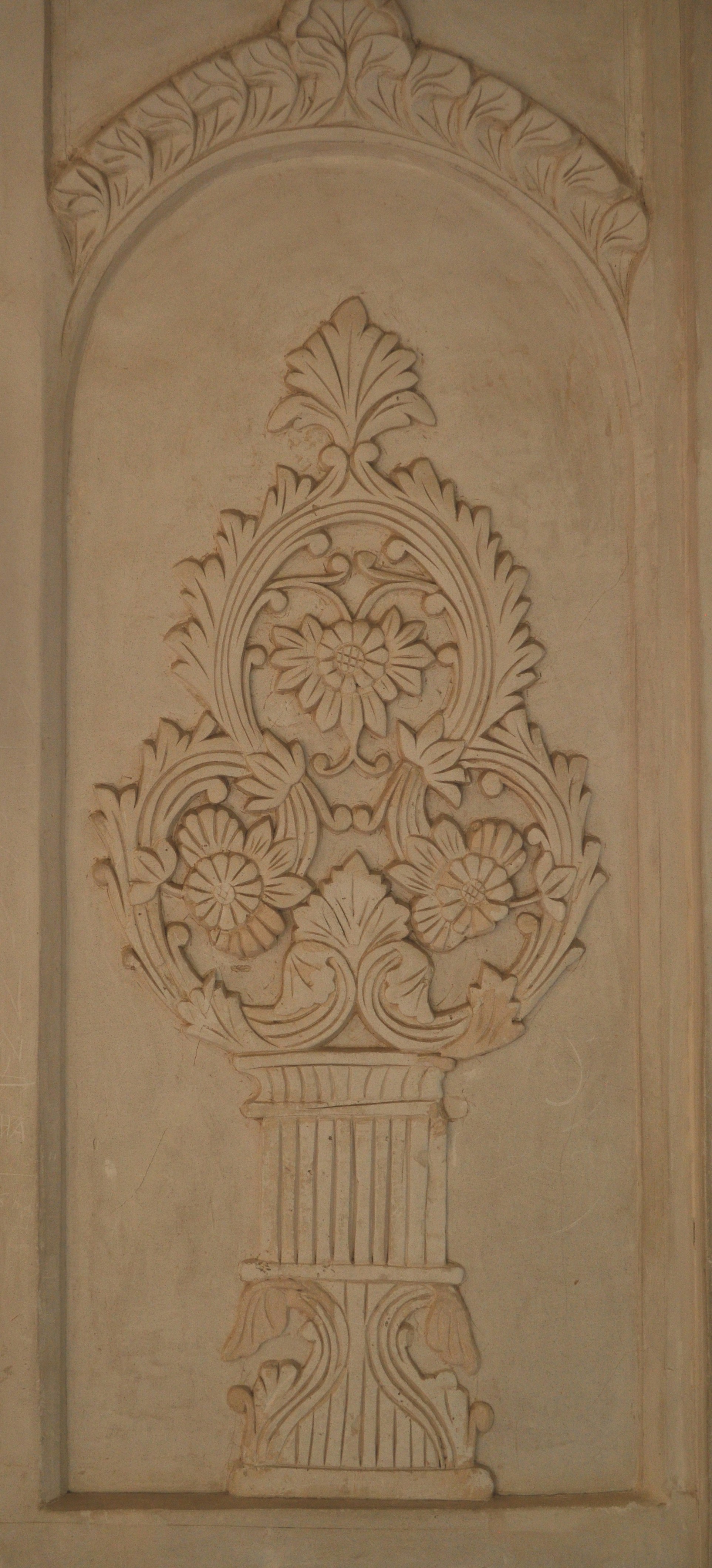 Intricate floral stucco reliefs decorating the walls of a historic Persian house. These handcrafted plaster ornaments showcase the elegance of traditional Iranian architecture, blending botanical motifs, symmetry, and centuries of architectural craftsmanship.