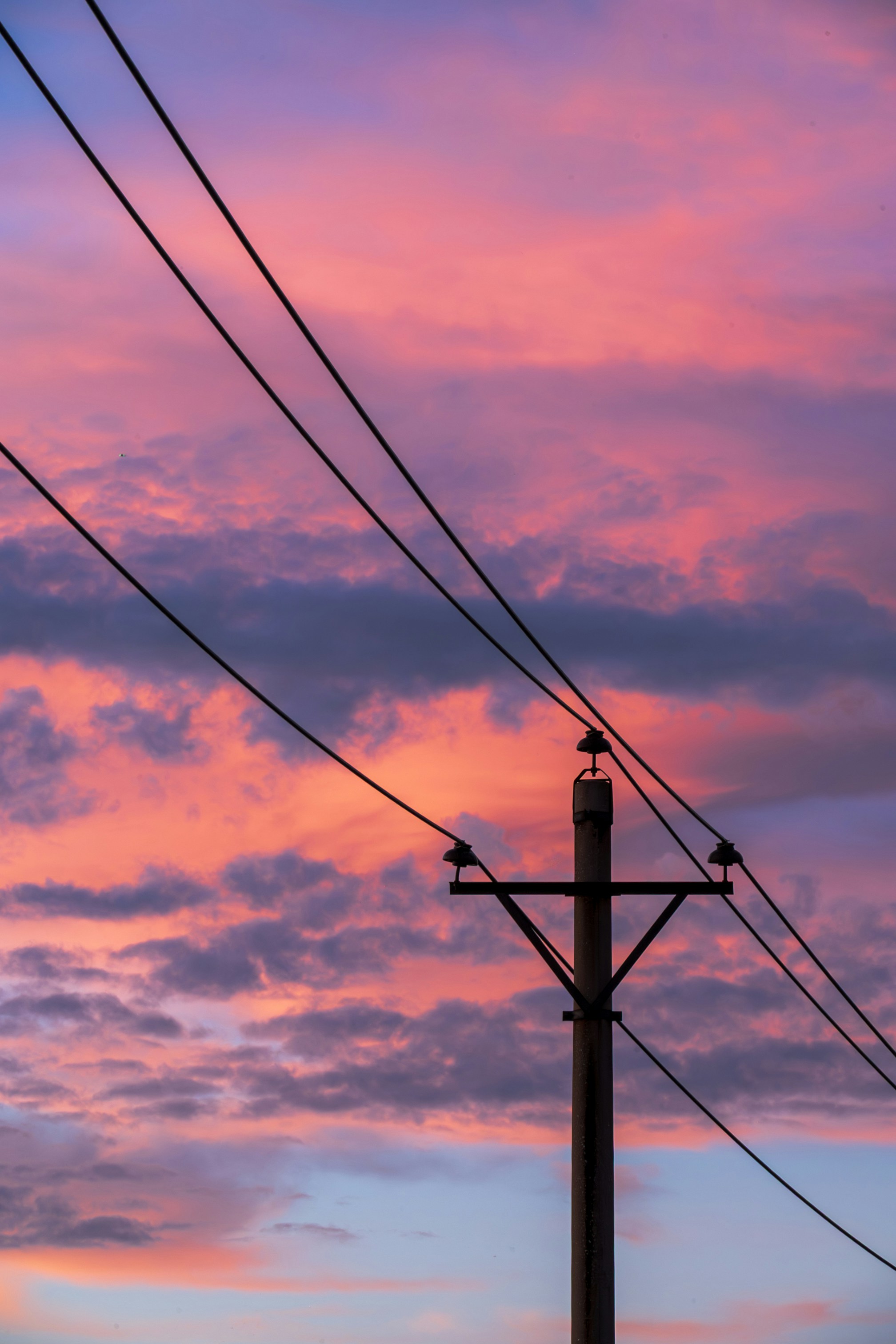 Crimson Sky Over a Quiet Power Pole
