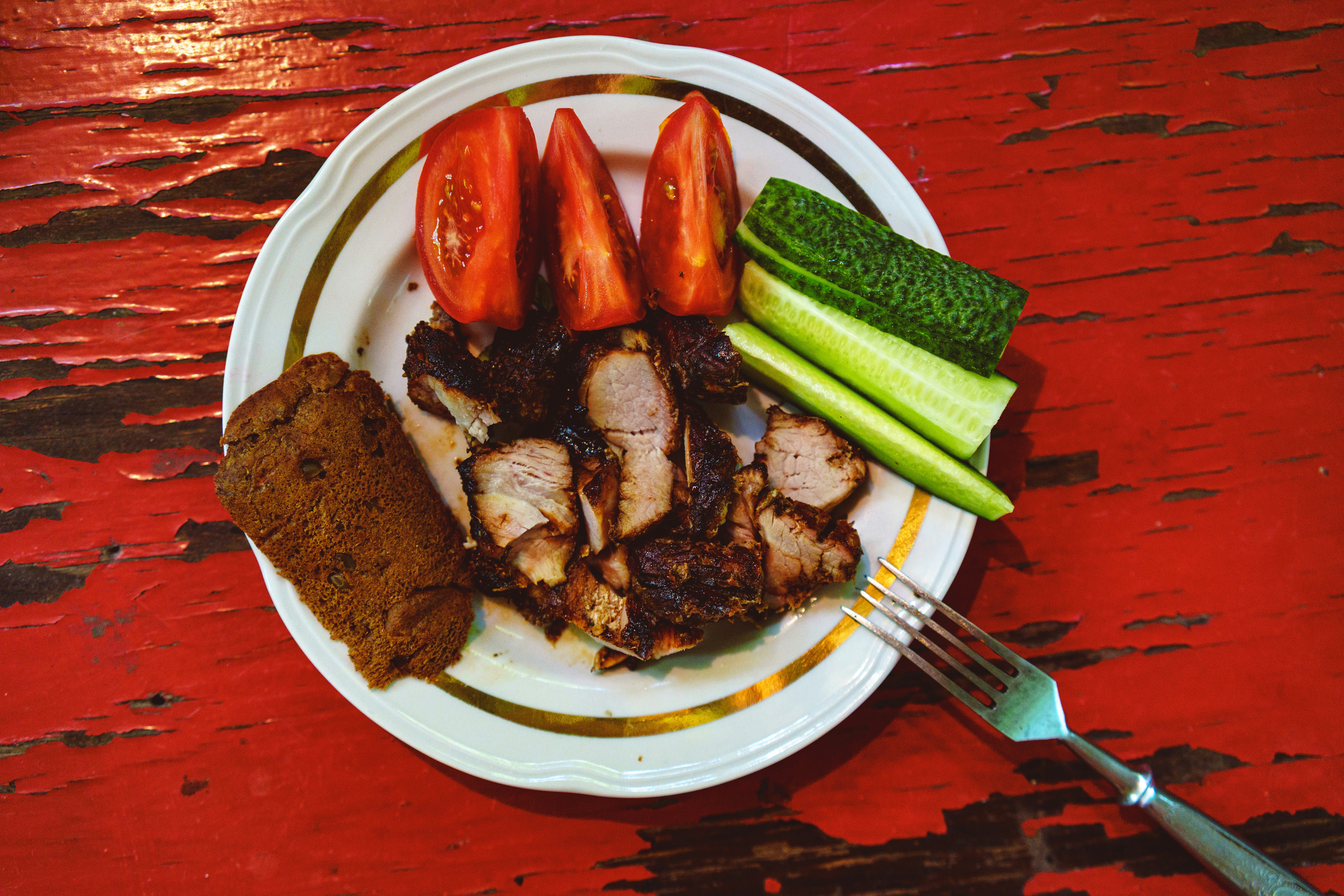 Charred Pork Medallions with Fresh Veg on a Rustic Plate