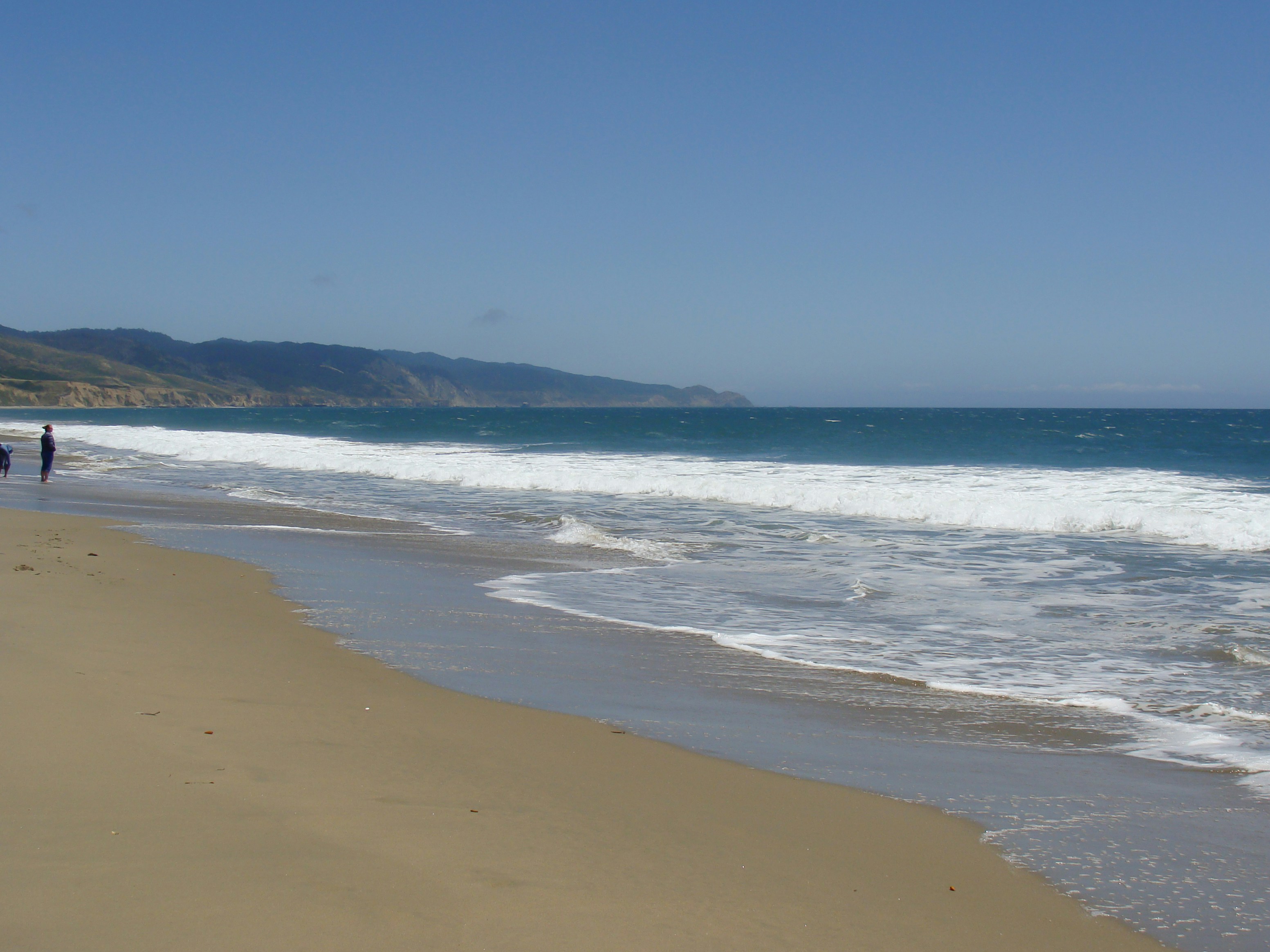 Lonely surfers on a windswept Channel coast