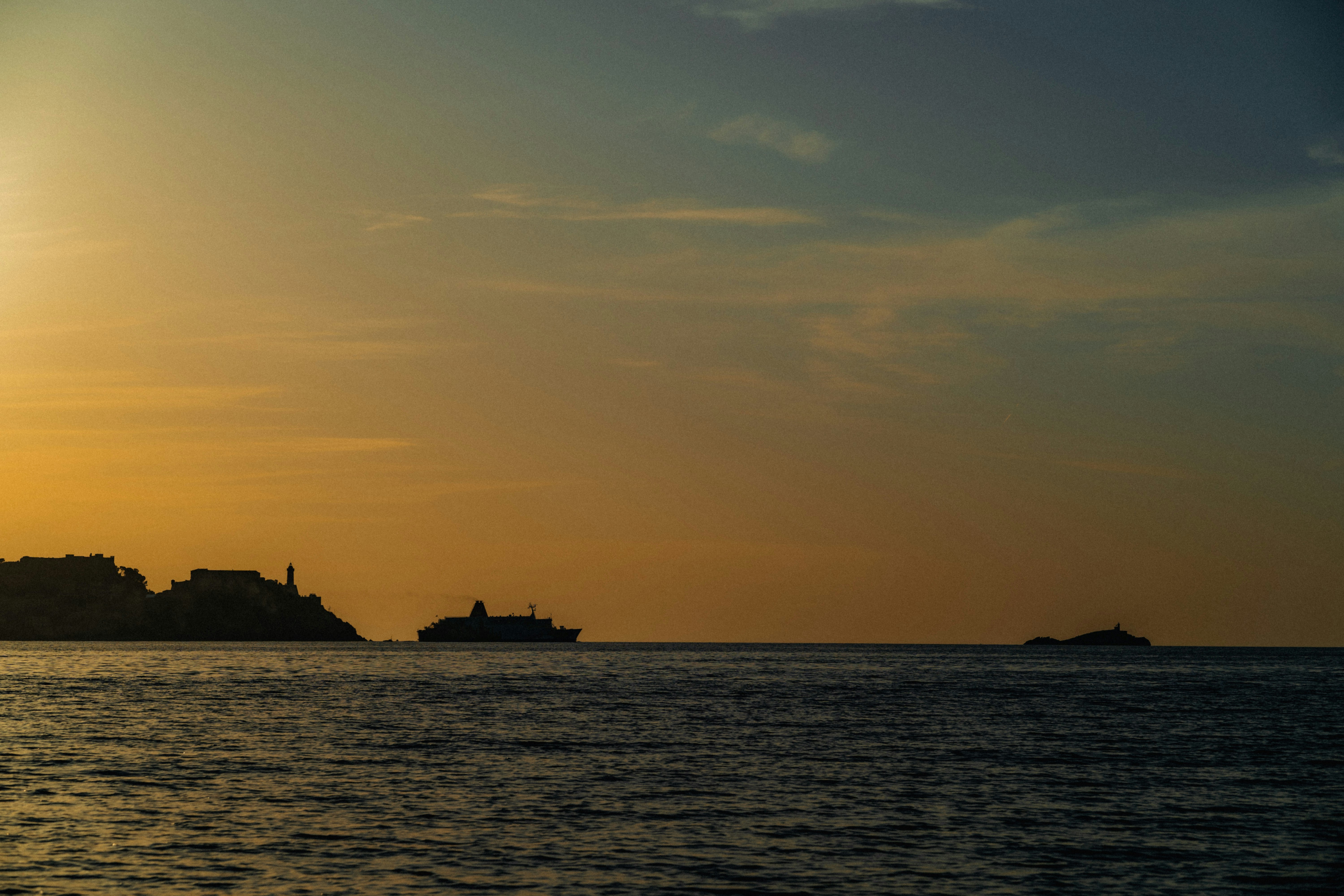 Sunset on Calm Seas: Ships on the Horizon