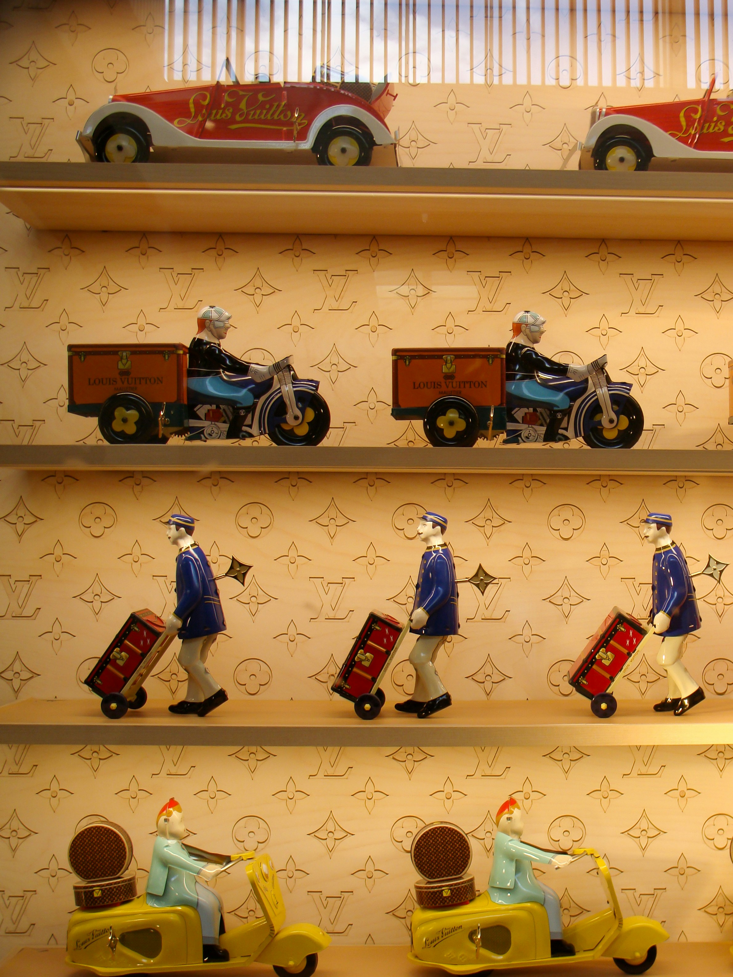 Playful Parade of Miniature Riders Beneath Luxurious Monogram Wallpaper
