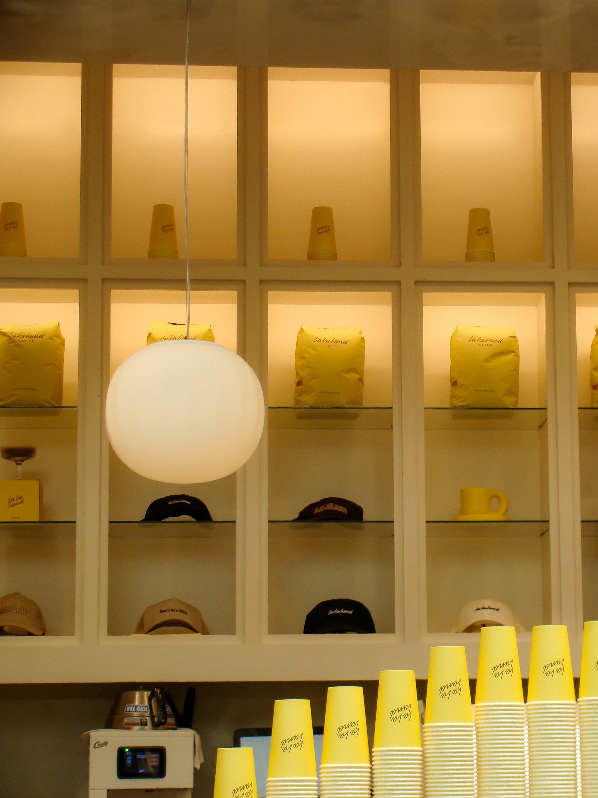 Yellow Cups, Soft Glow: A Warm Café Display
