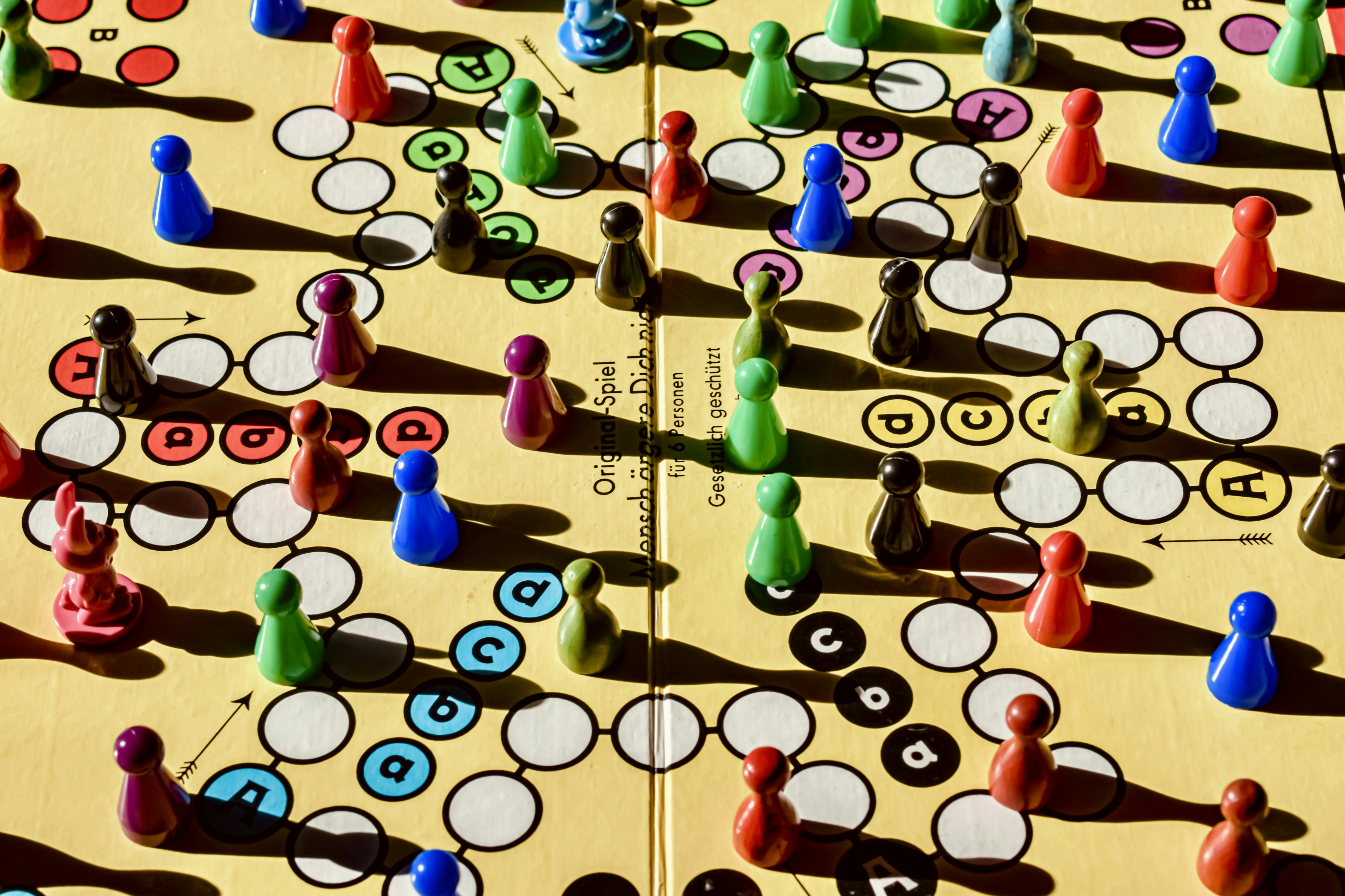Strategic Move Across a Colorful Board: A Pinboard of Paths and Players