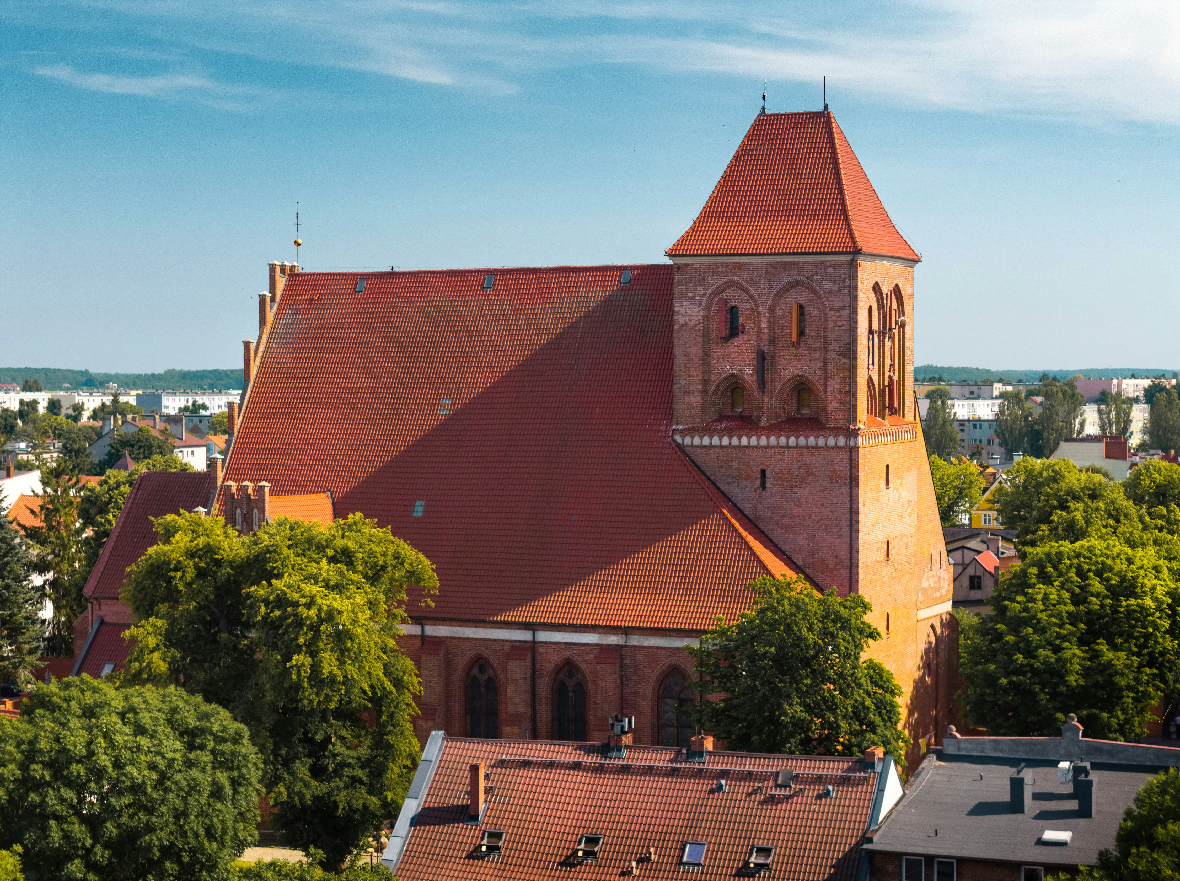 Sunlit brick church under a crisp blue sky
