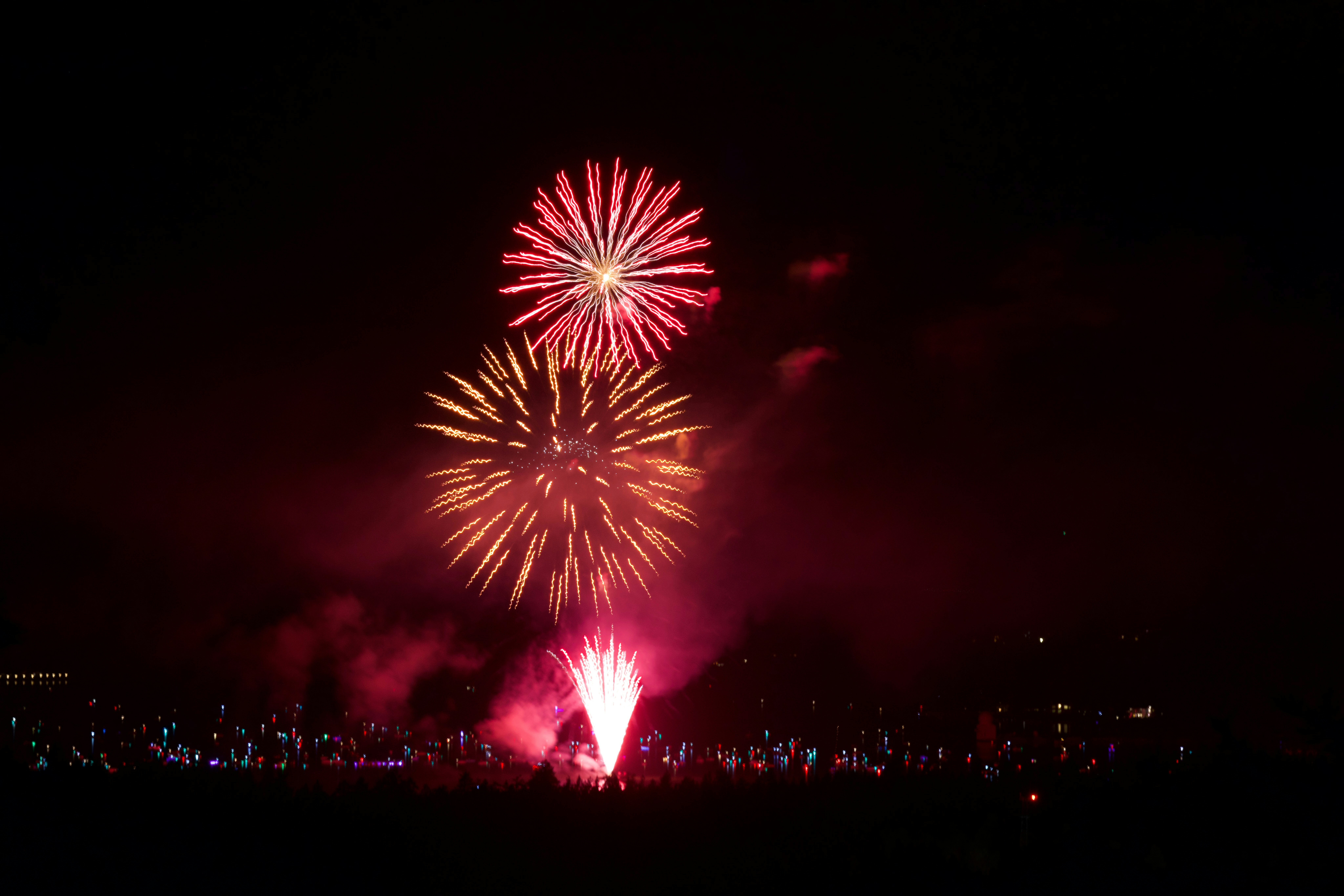 Night Sky Ignition: Fireworks Bloom Over a Silent Crowd