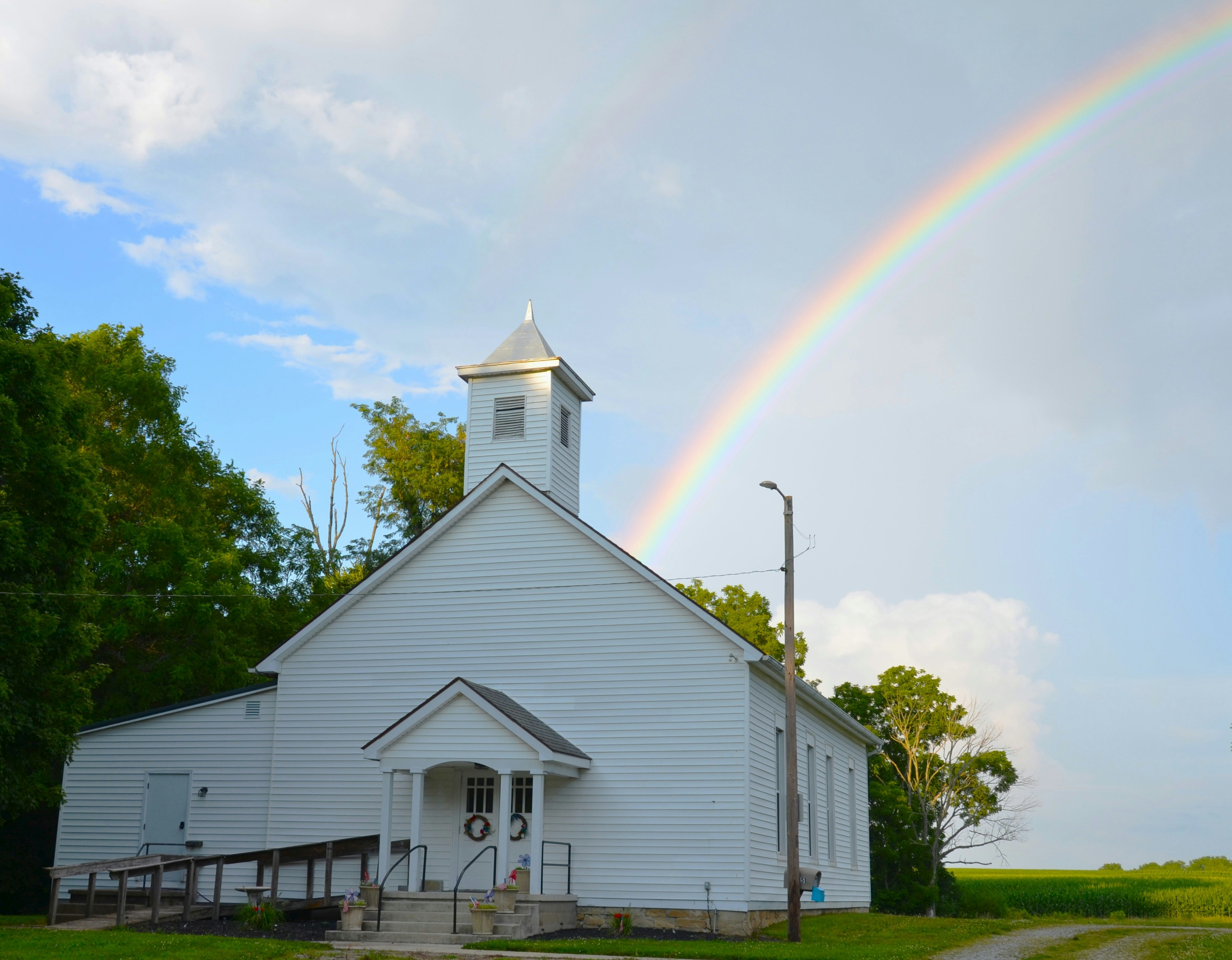 White chapel under a rainbow: a tranquil frontier scene