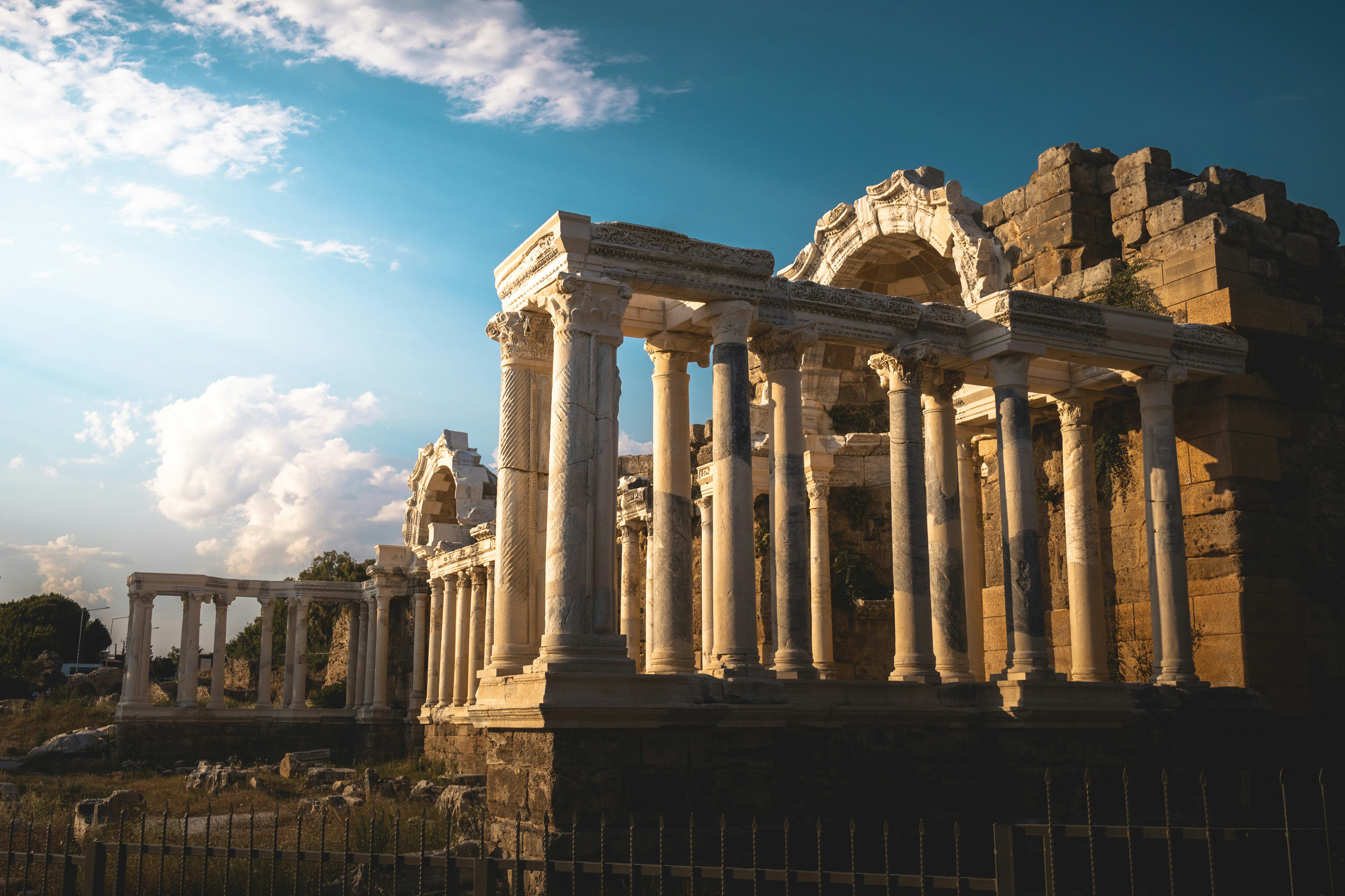 Sunlit Ruins: Classical Columns Framing a Distant Arch