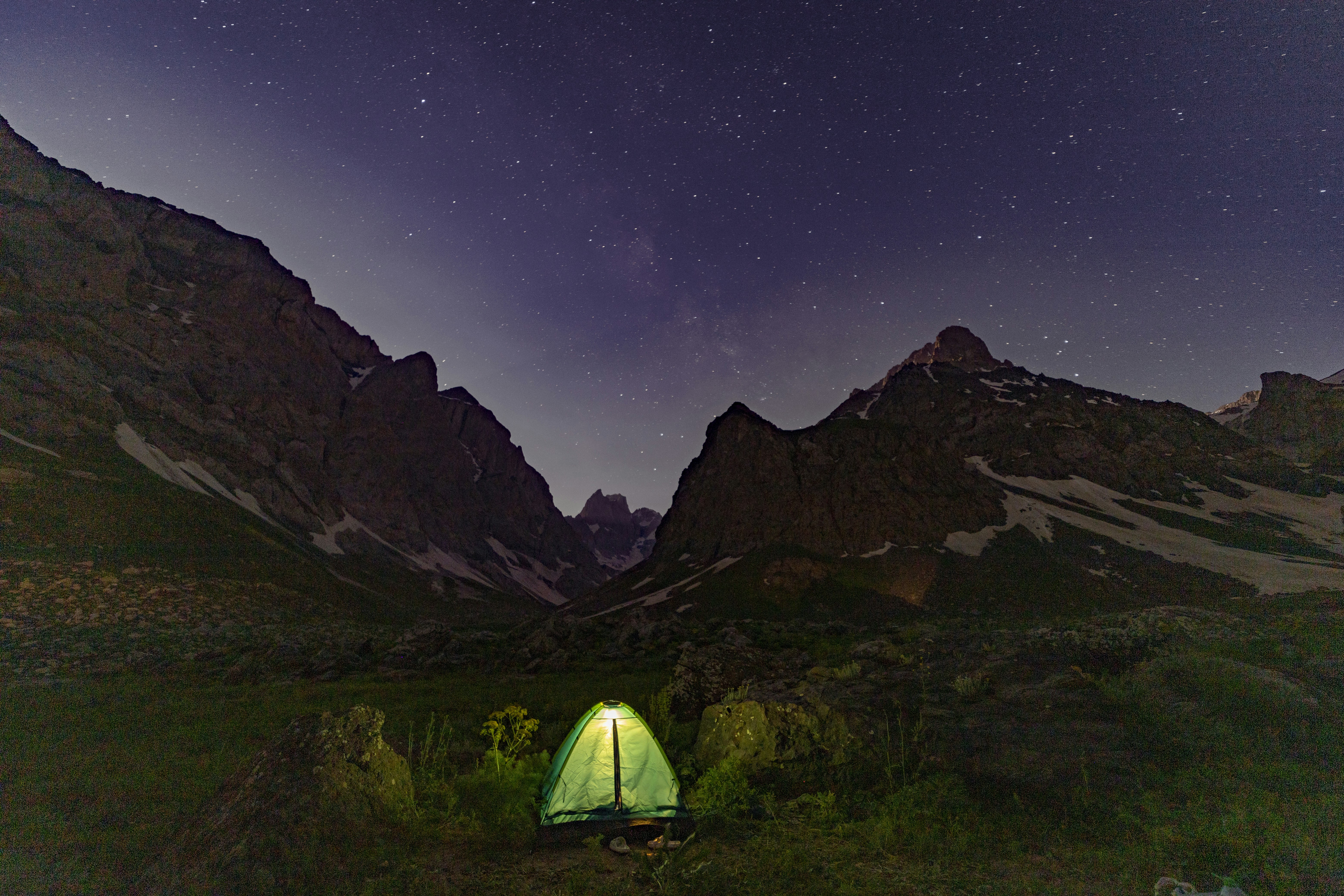 Green Tent Under a Starry Cloak in Alpine Night