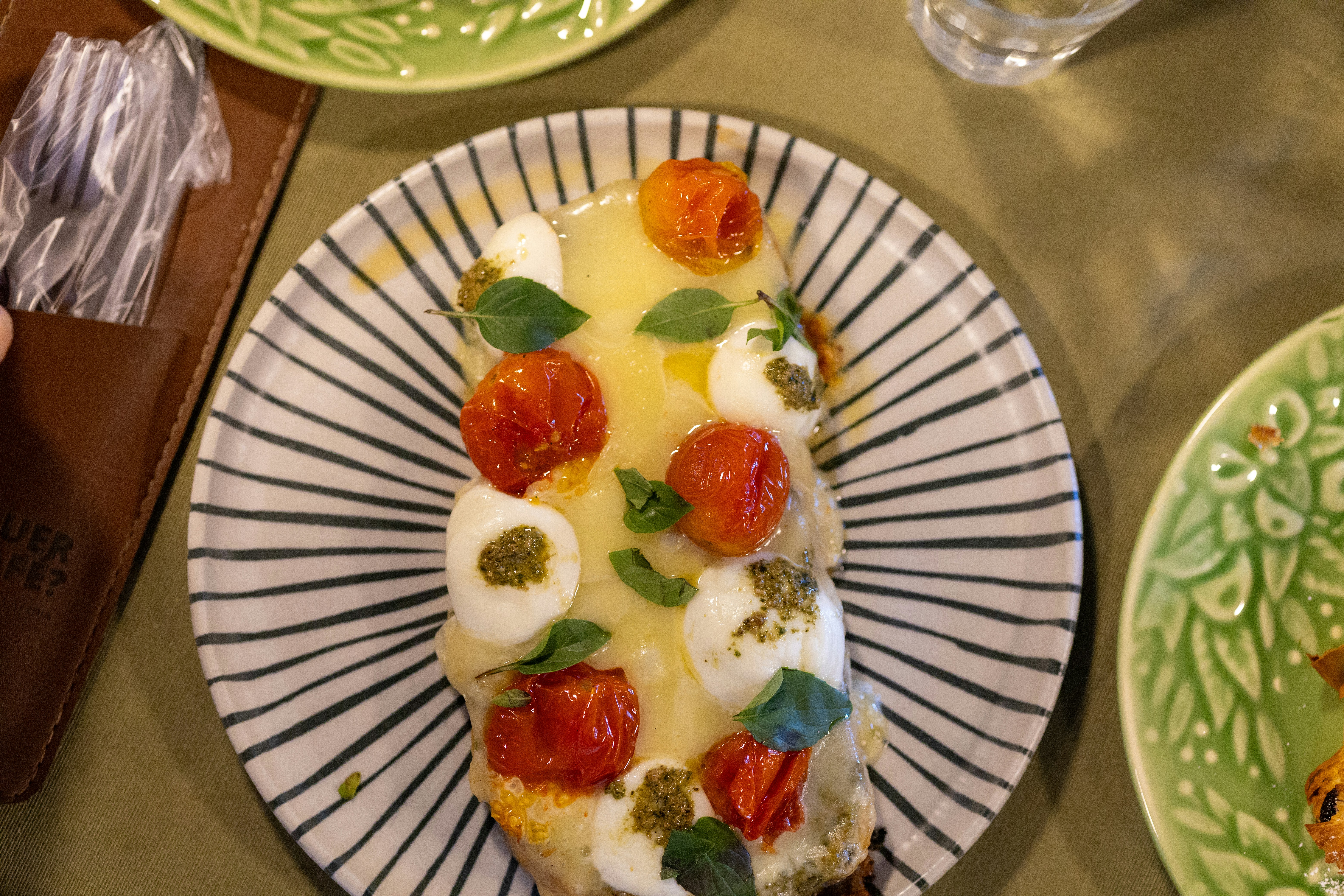 Strawberry-topped Burrata Ensemble on a Striped Plate