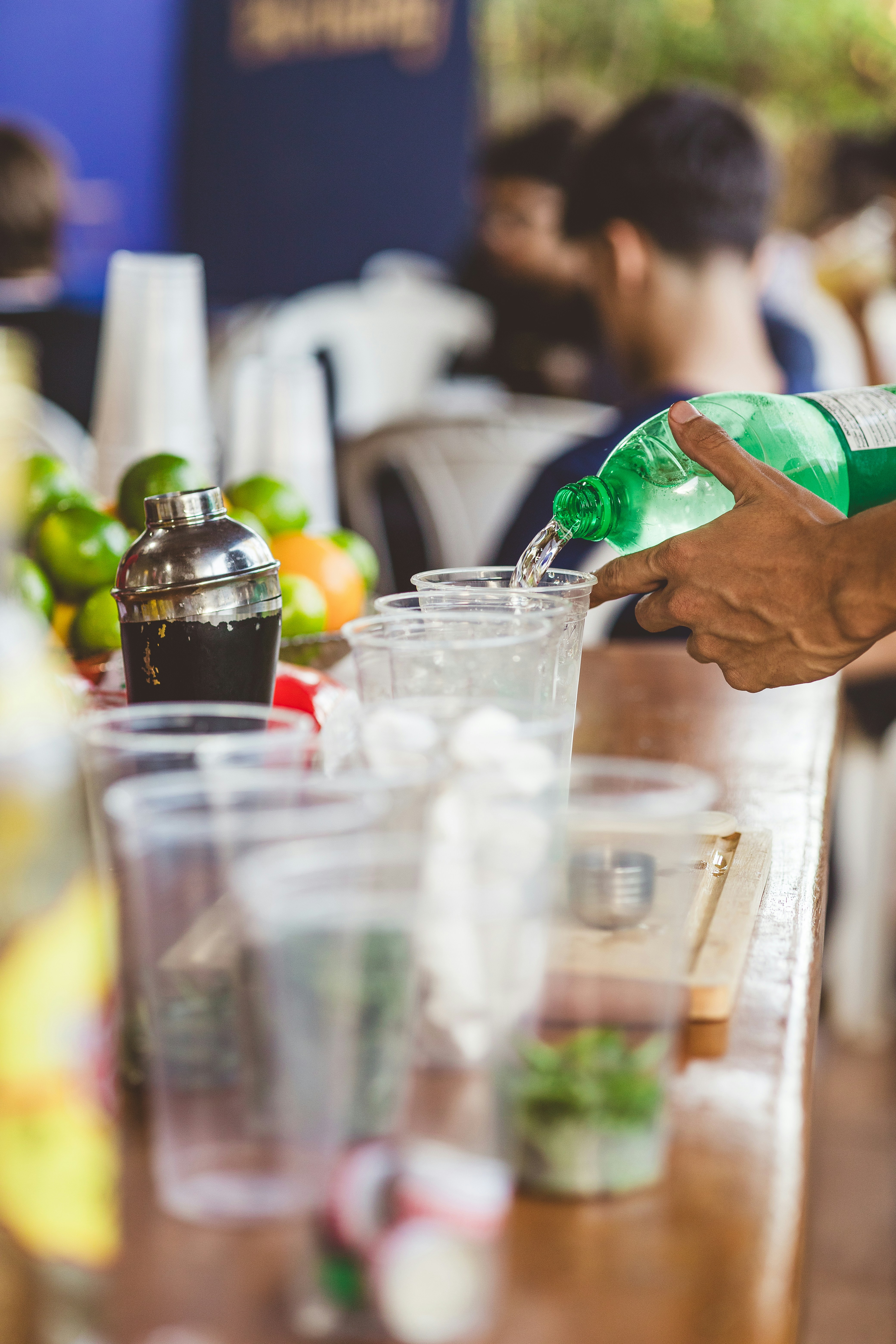 Pouring Soda at a Busy Bar Counter