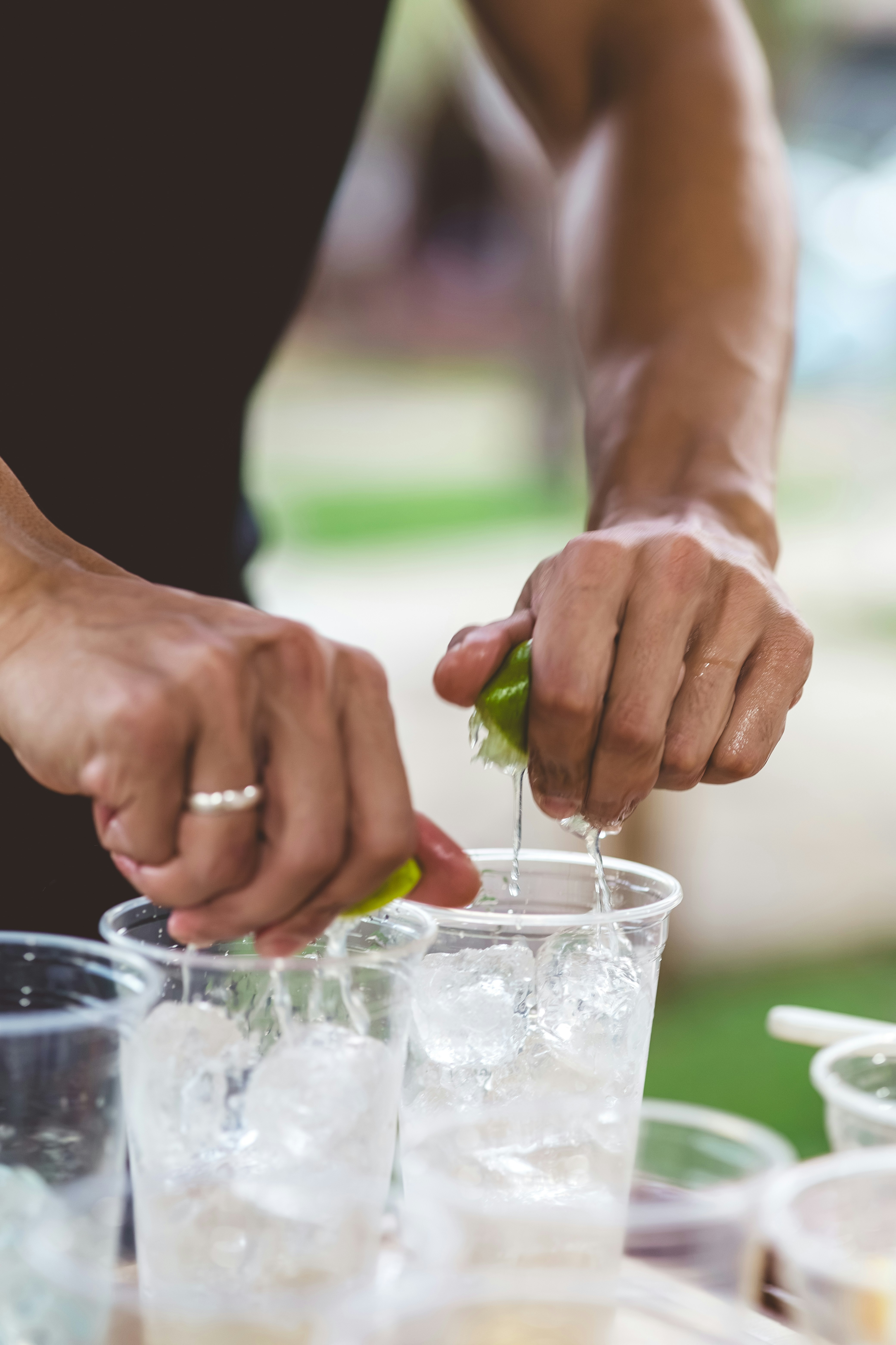 Citrus Splash: Hands Squeeze Fresh Juice Over Ice