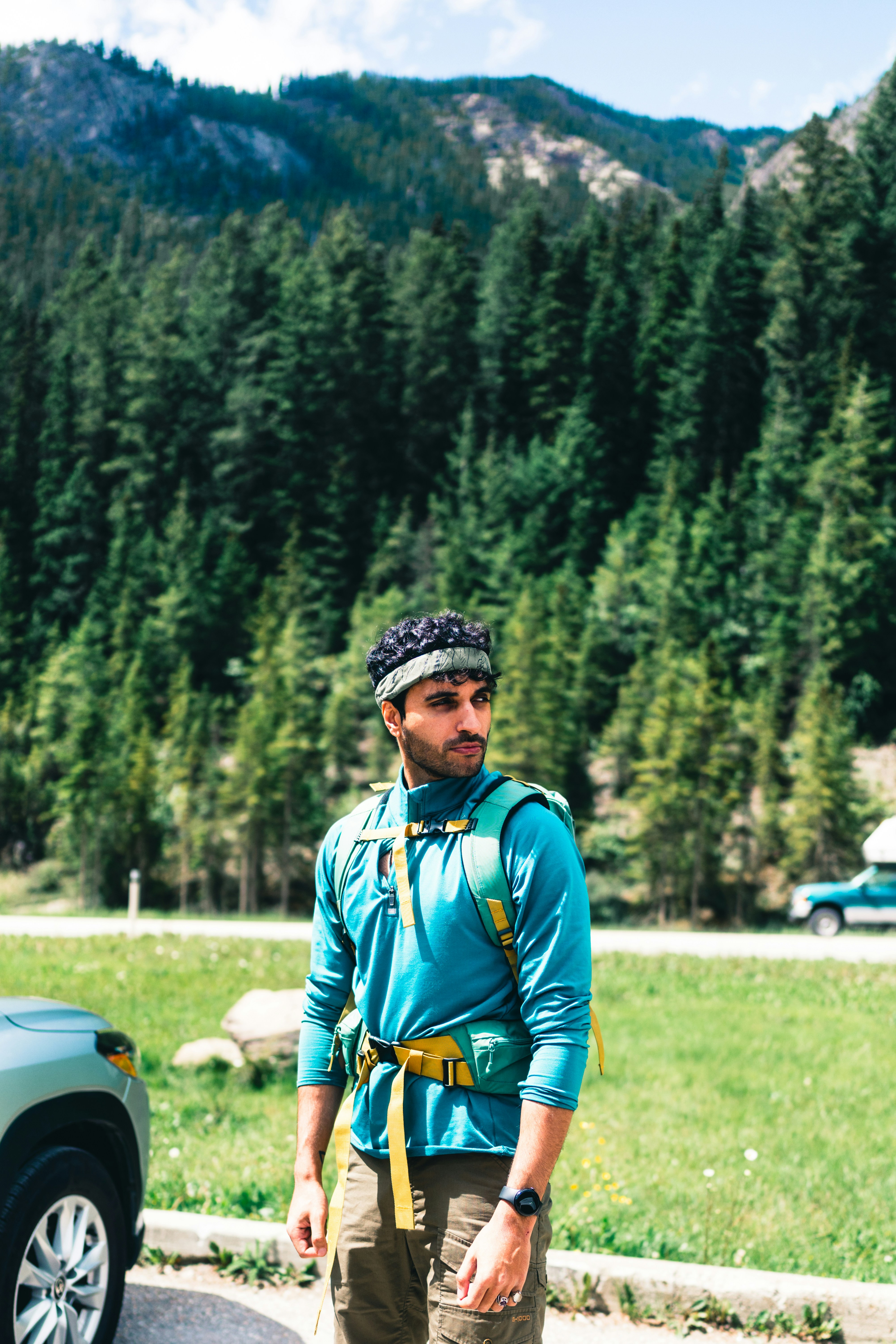 Blue-clad hiker pausing at a forested overlook
