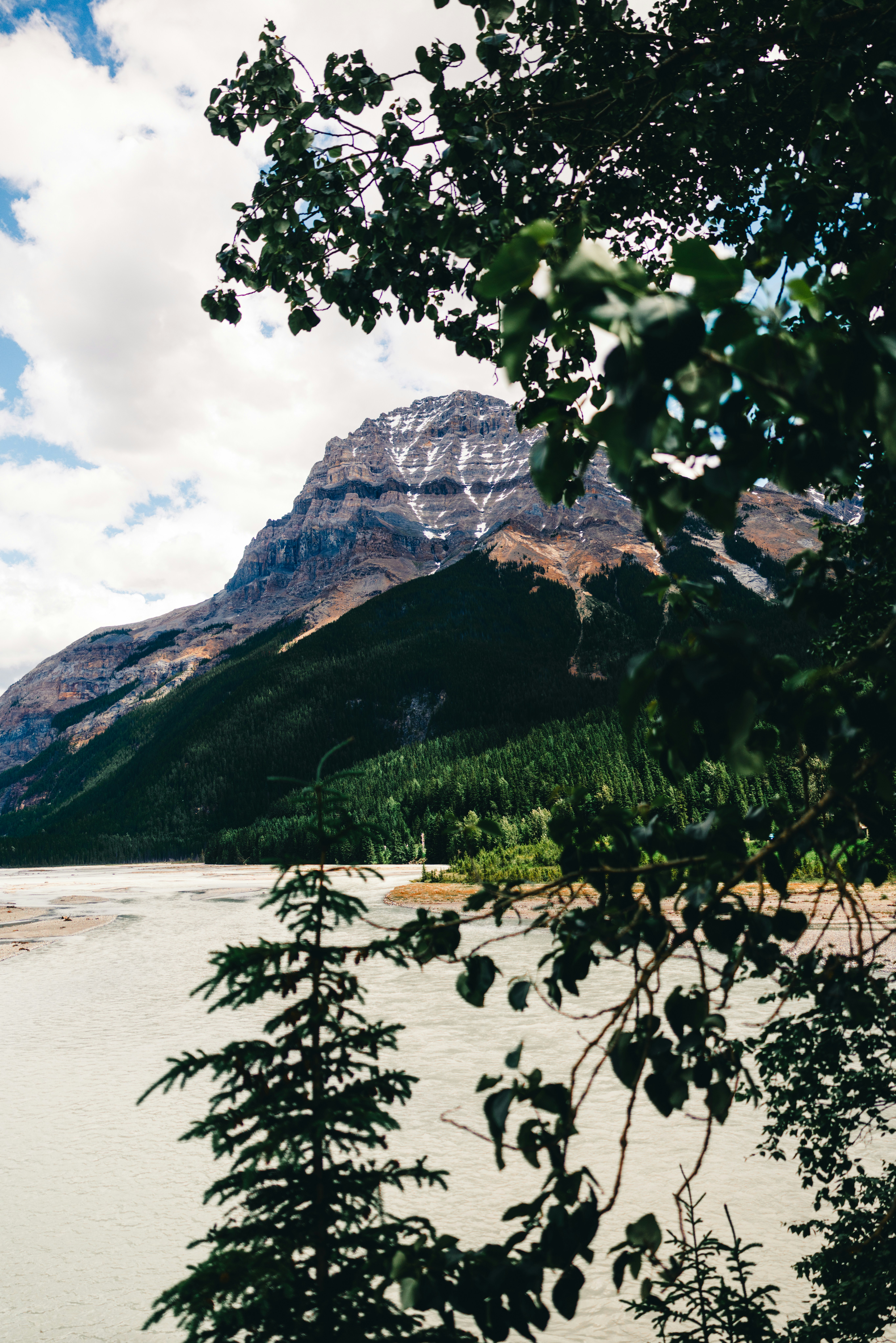 Framed Peaks Beyond a Backlit Lake