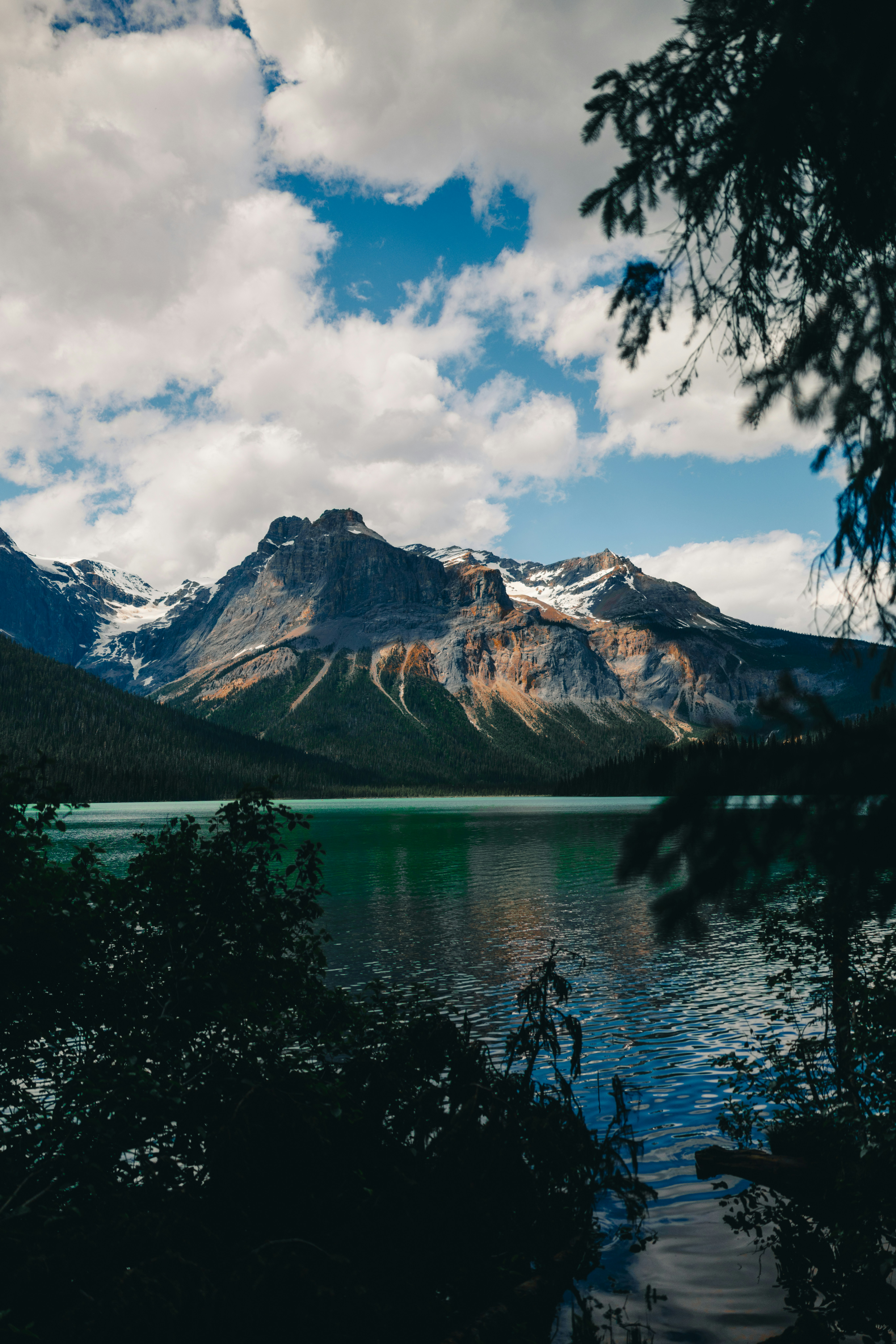 Emerald Lacustrine Peaks under a Sky of Cumulus