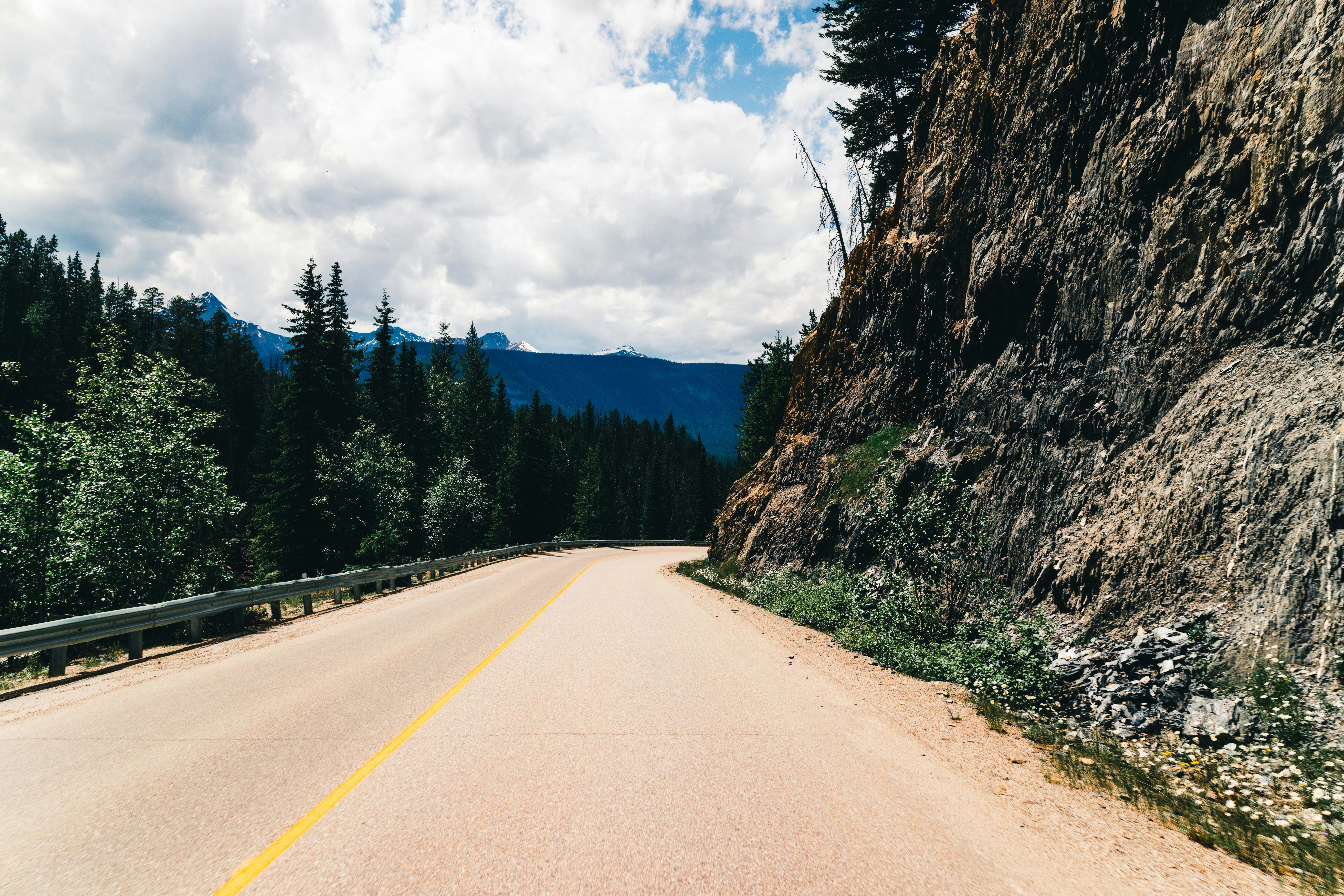 Along the Mountain Road: Sunlit Asphalt and Cliffside Highway